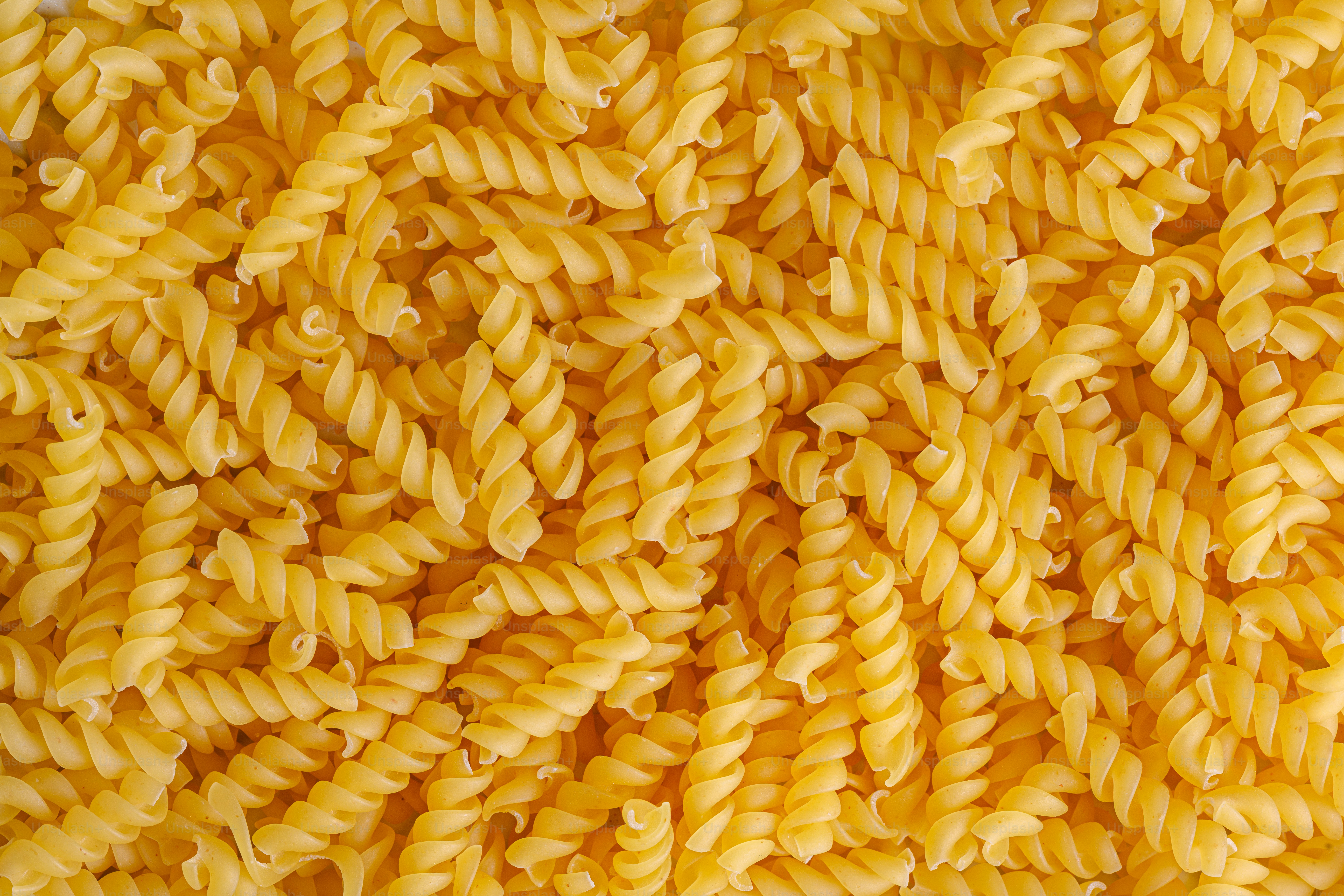 A pile of fusilli pasta. photo – Wallpaper Image on Unsplash