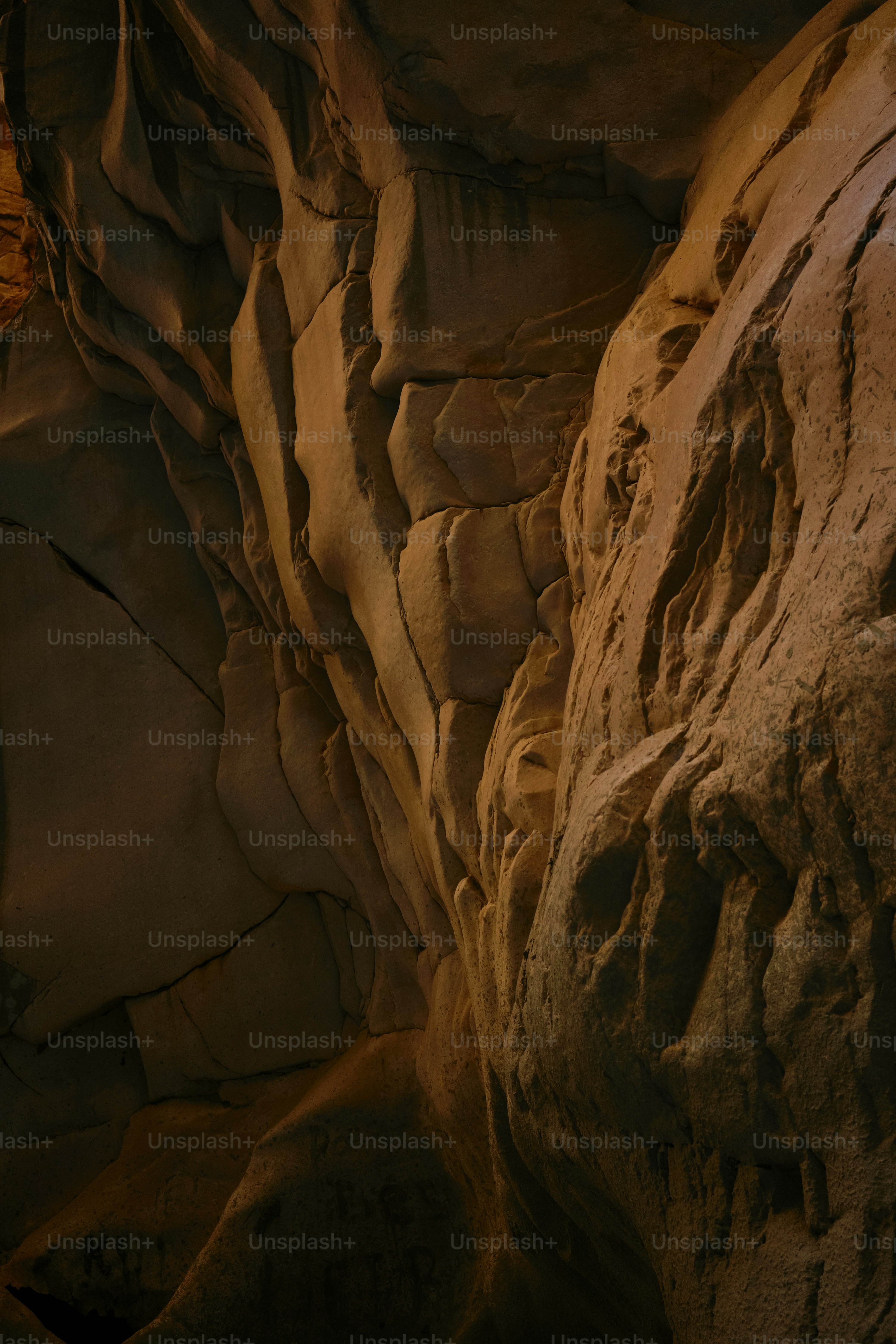 Textured rock formations inside a cave. photo – Minimal Image on Unsplash
