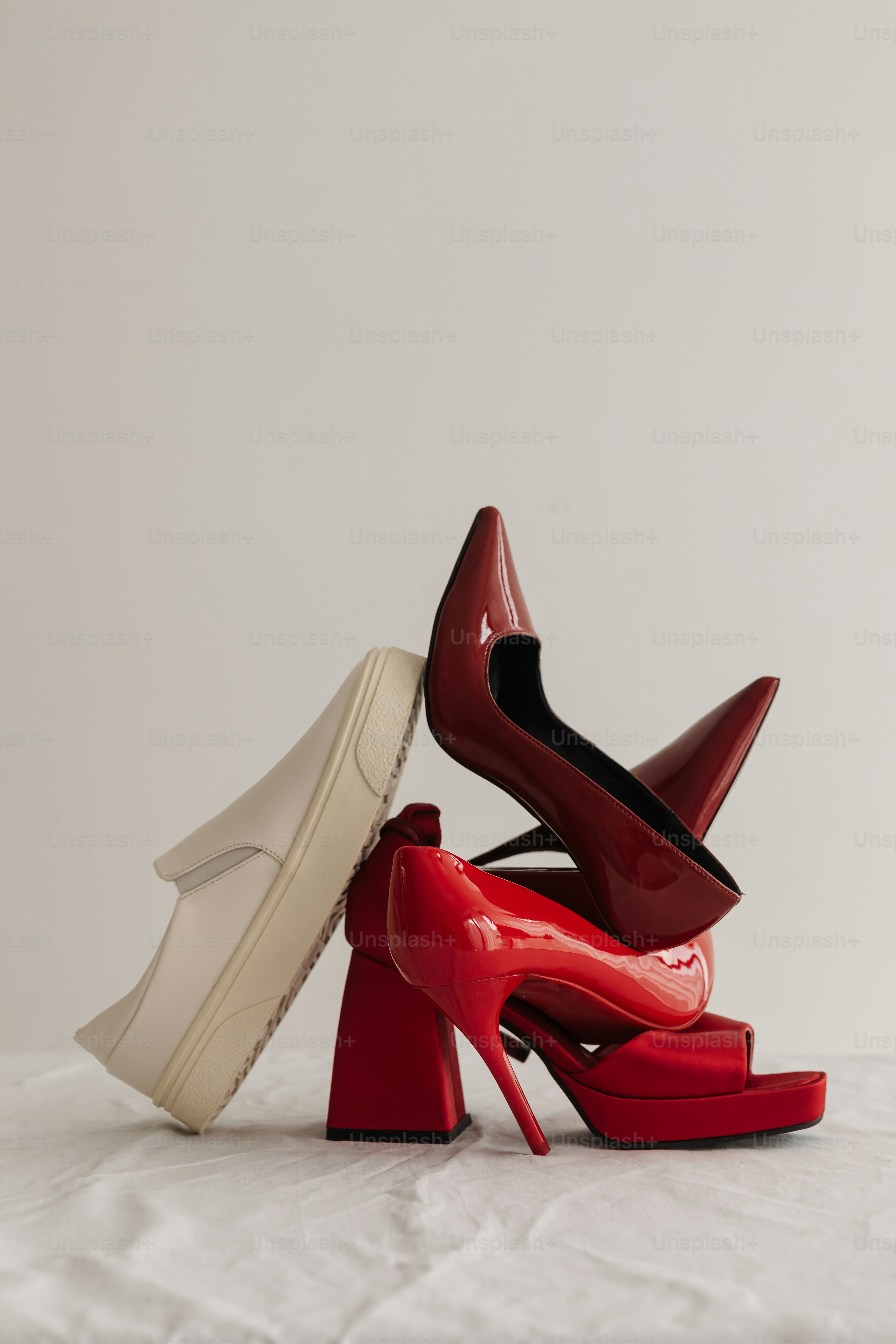 Shoes, in different colors and styles, are stacked. photo – Shoes Image ...