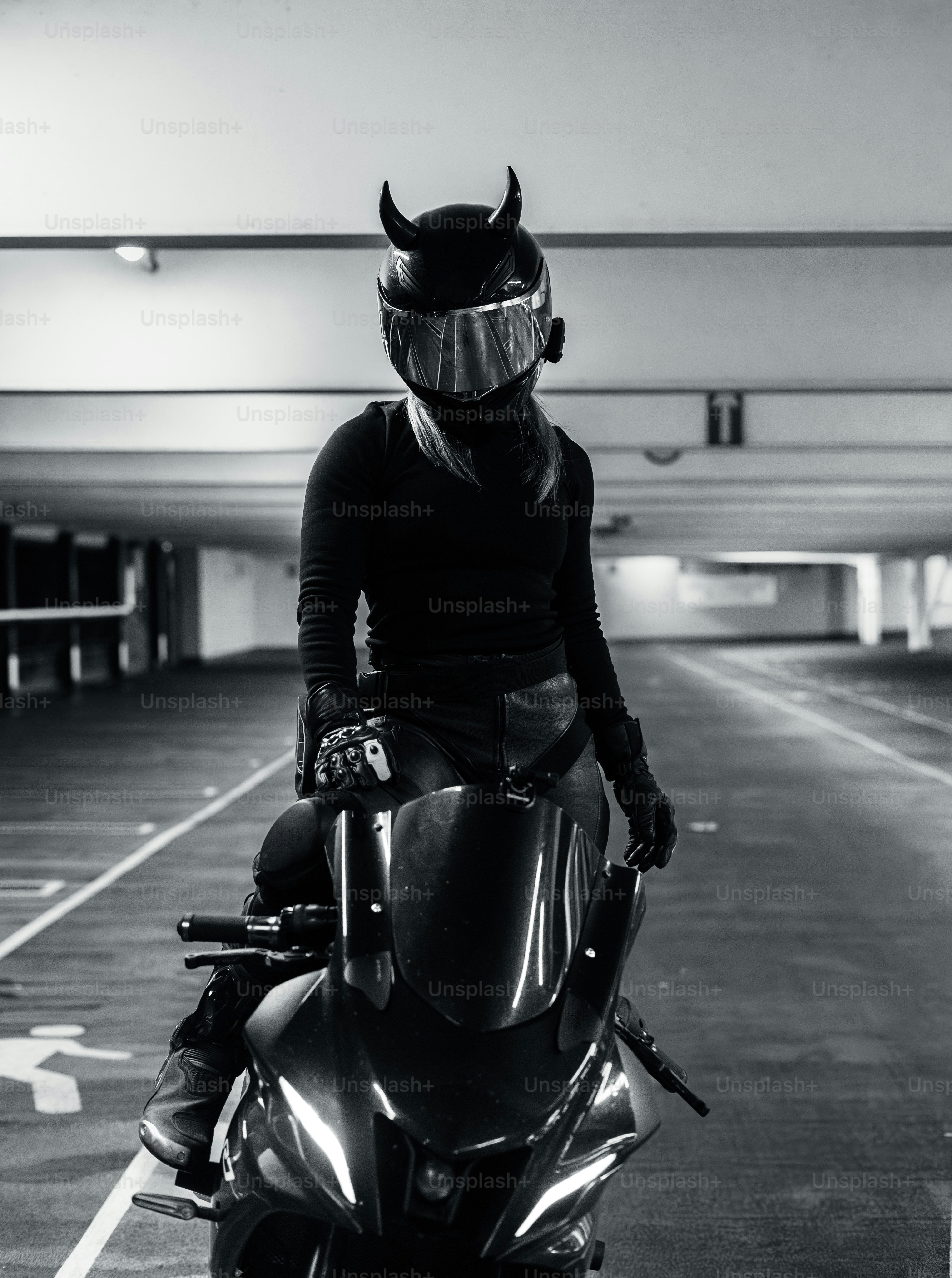 A rider in a devil-horned helmet poses on a bike. photo – Motorbike ...