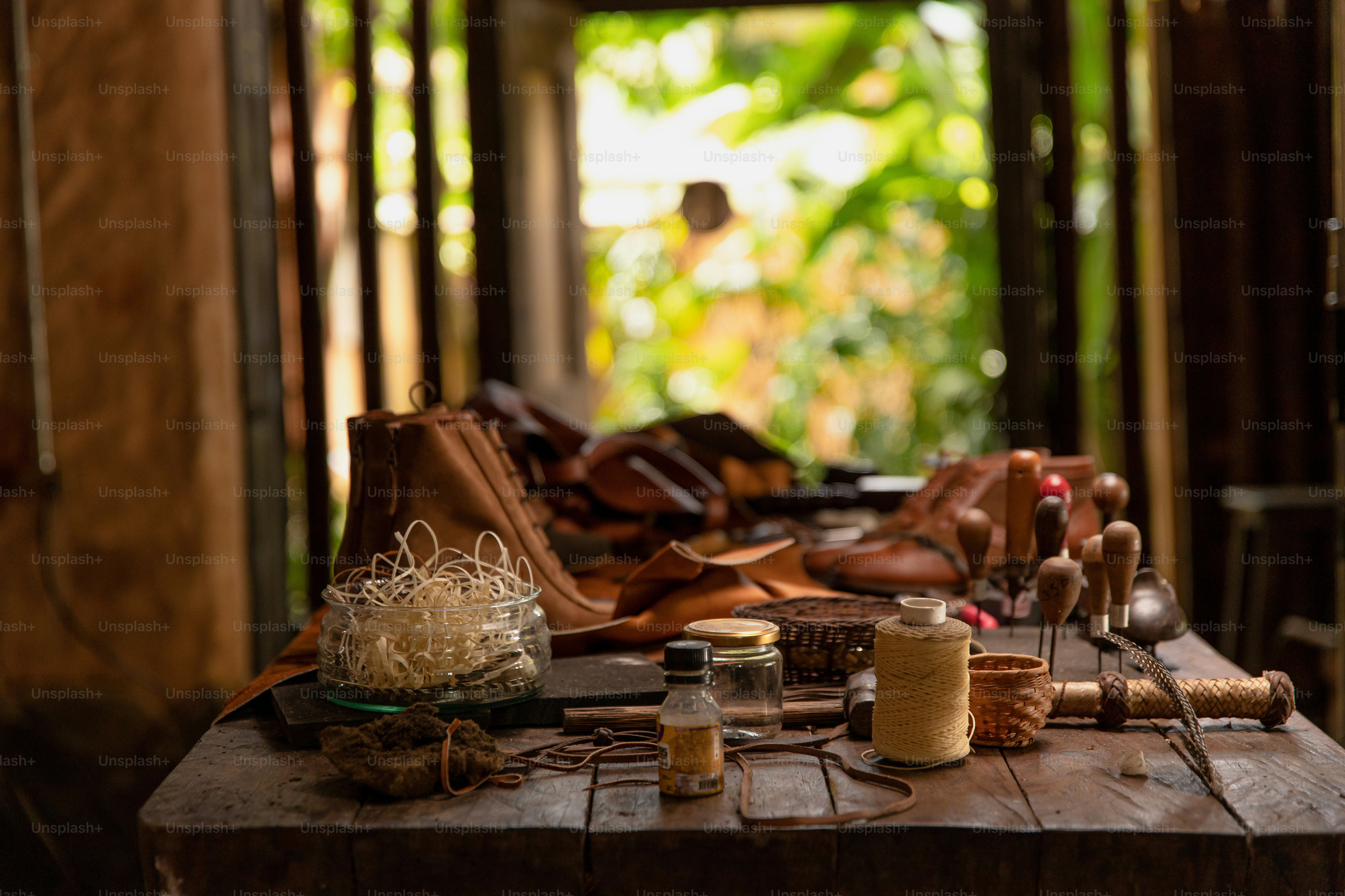 Leatherworking tools and unfinished projects on a workbench. photo ...