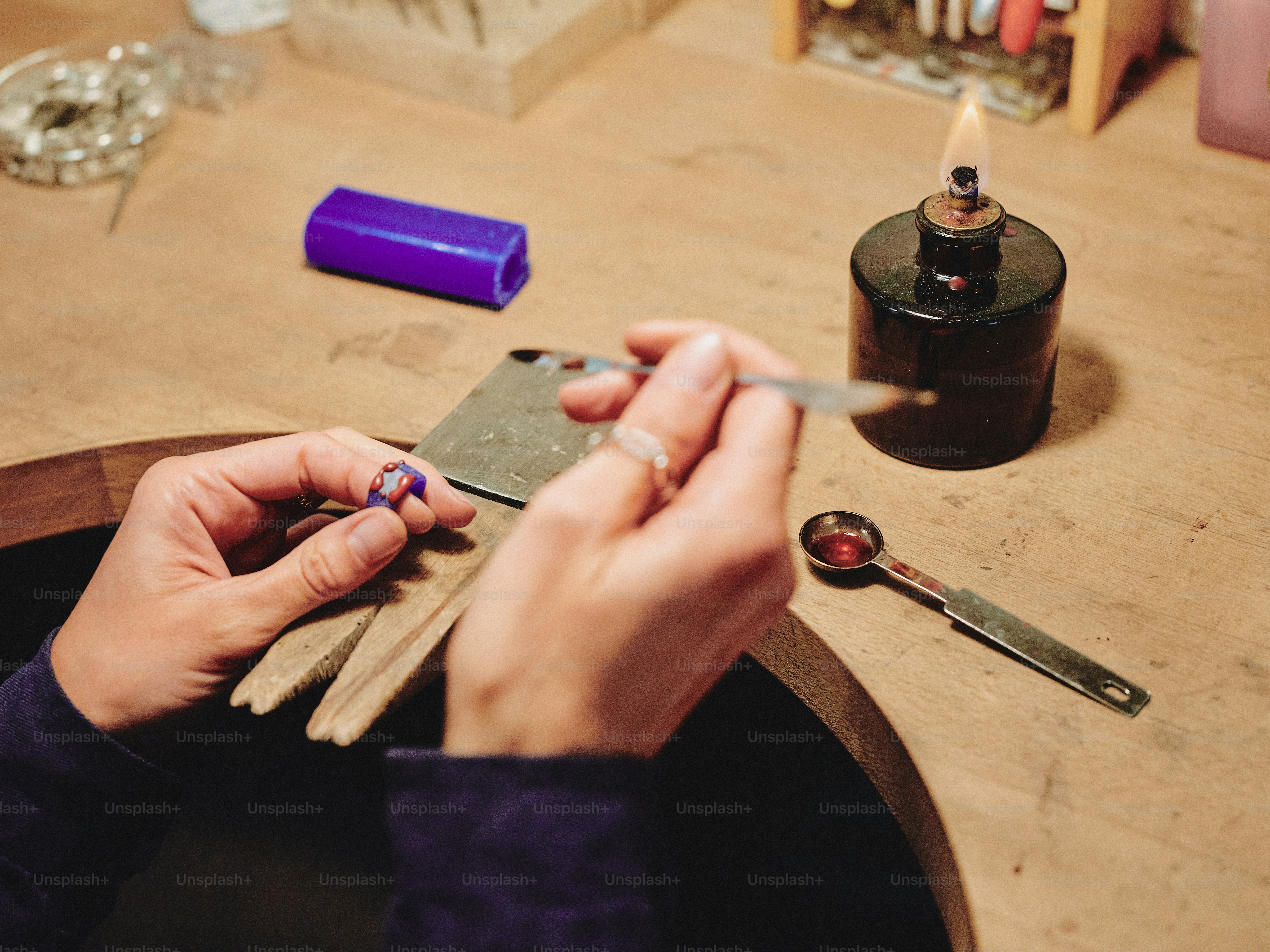 A jeweler works on a ring with tools. photo – Luxury Image on Unsplash