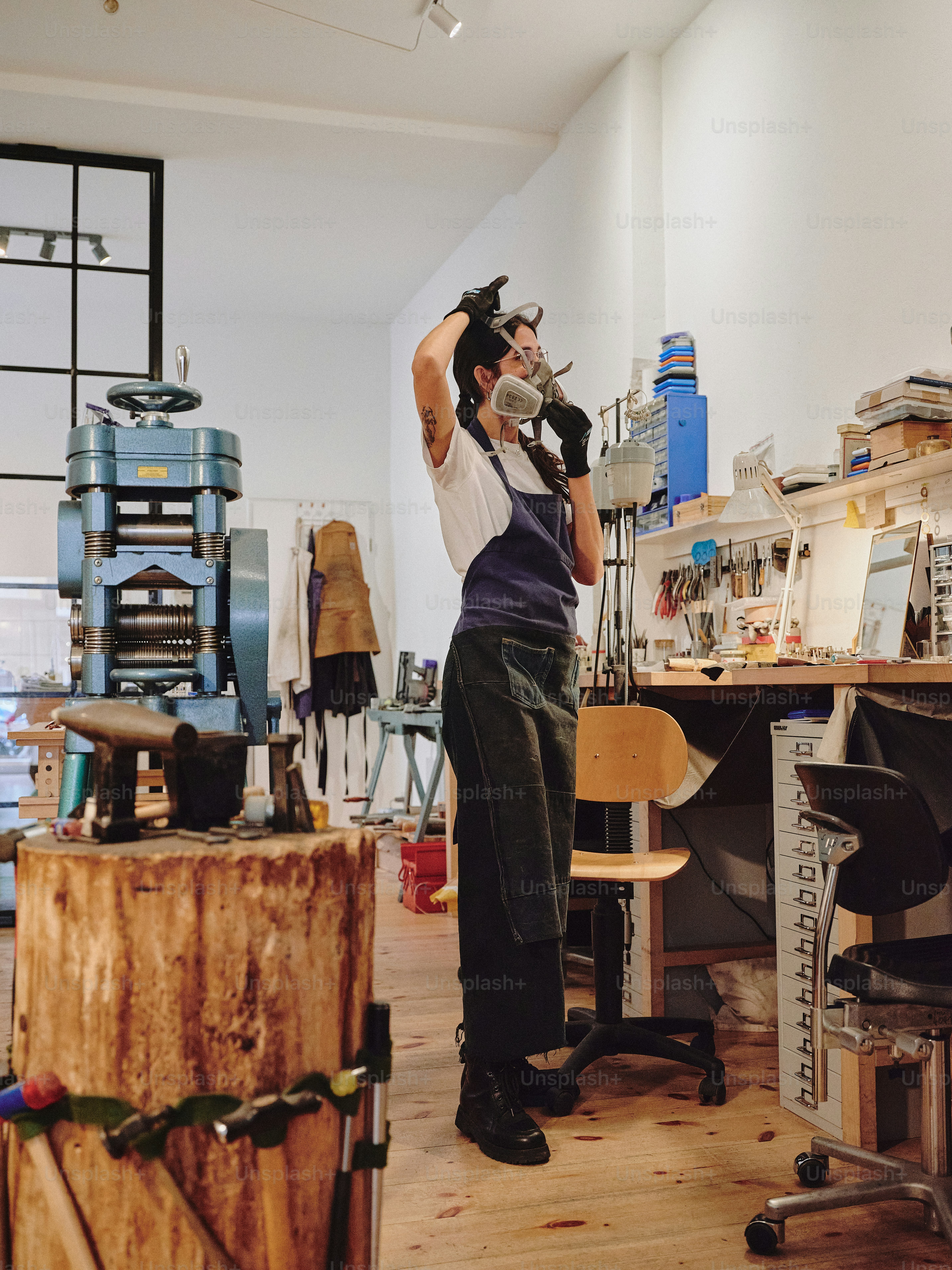 Artist prepares to work in a busy studio. photo – Portrait Image on ...