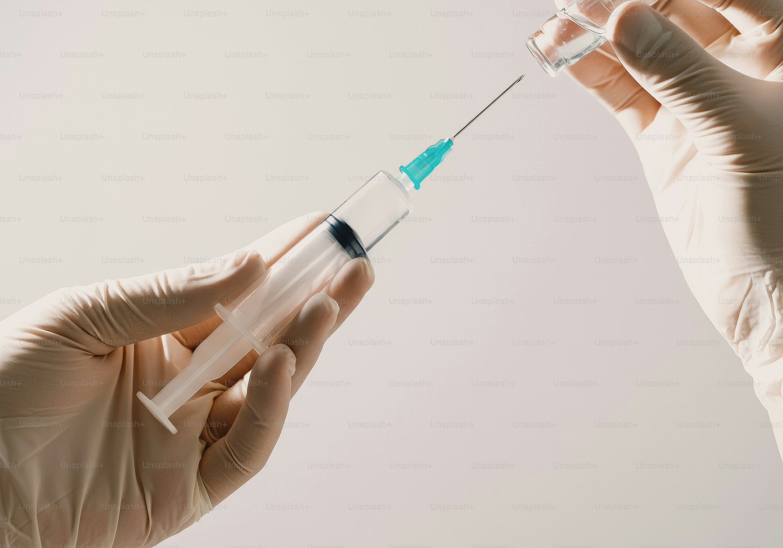 Hands prepare a syringe for an injection. photo – Health Image on Unsplash