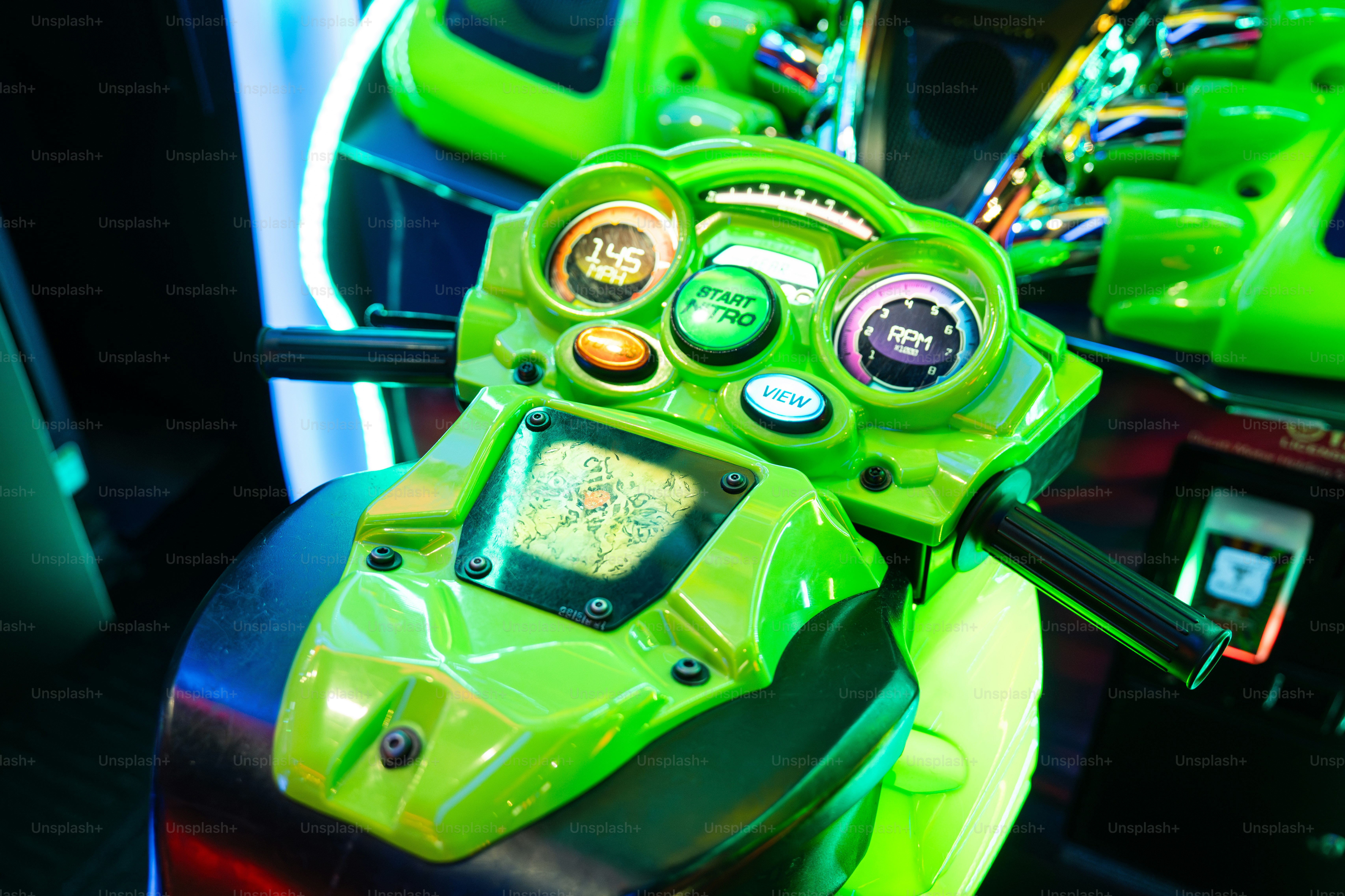 A green arcade motorcycle game's controls are shown. photo – Gaming ...