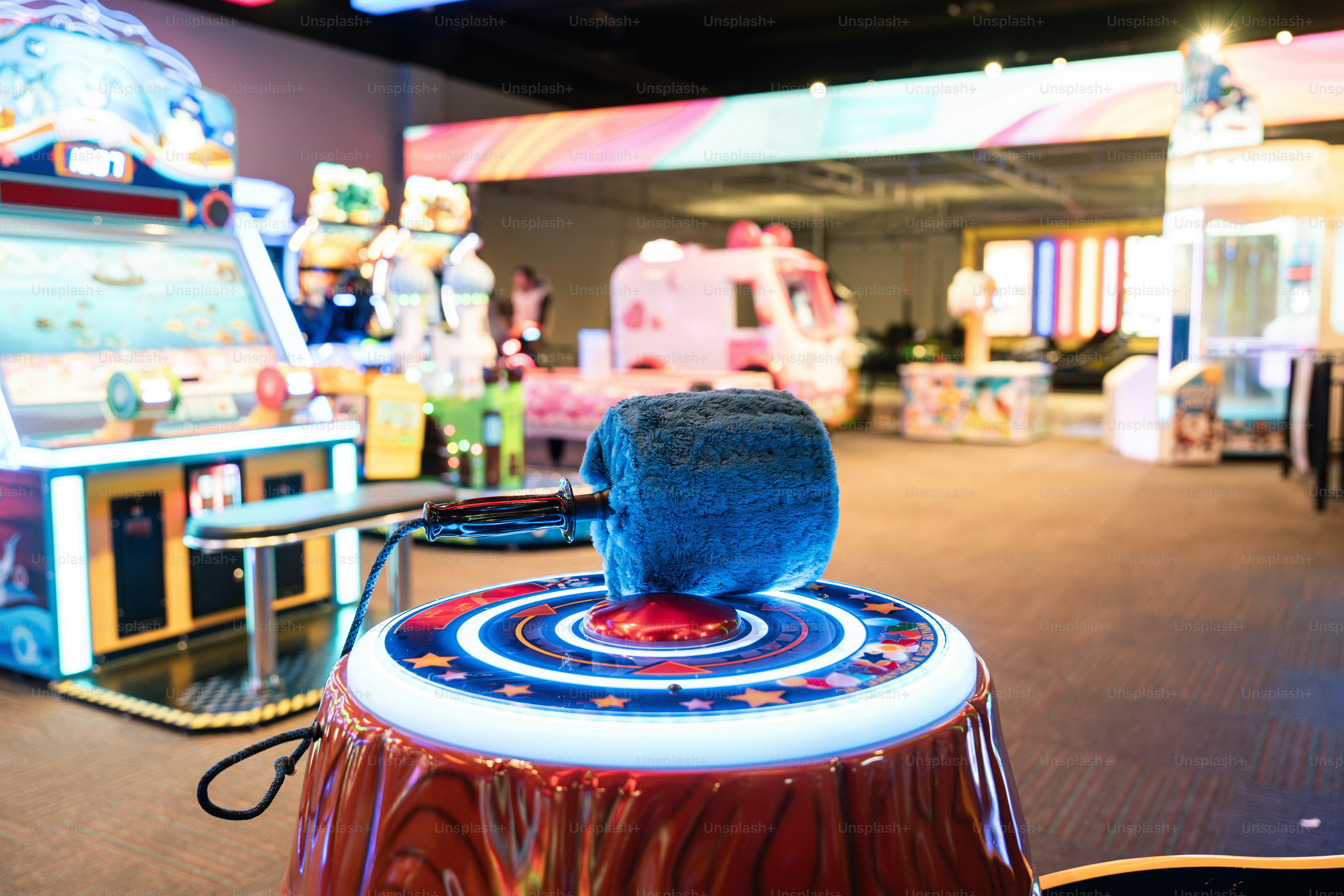 An arcade game hammer sits on a pedestal. photo – Gaming Image on Unsplash