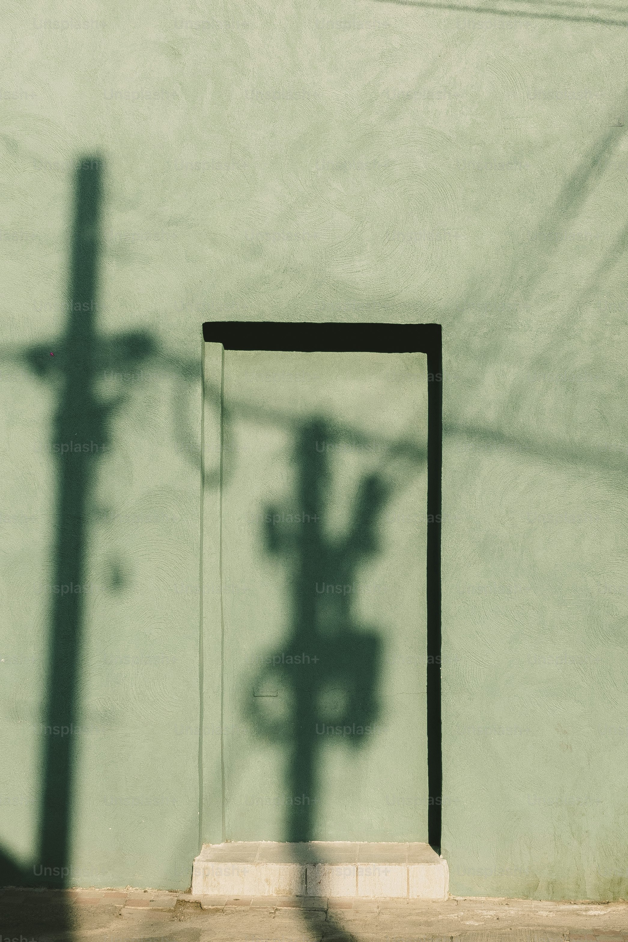 Shadows of poles and a door on a wall. photo – Wallpaper Image on Unsplash