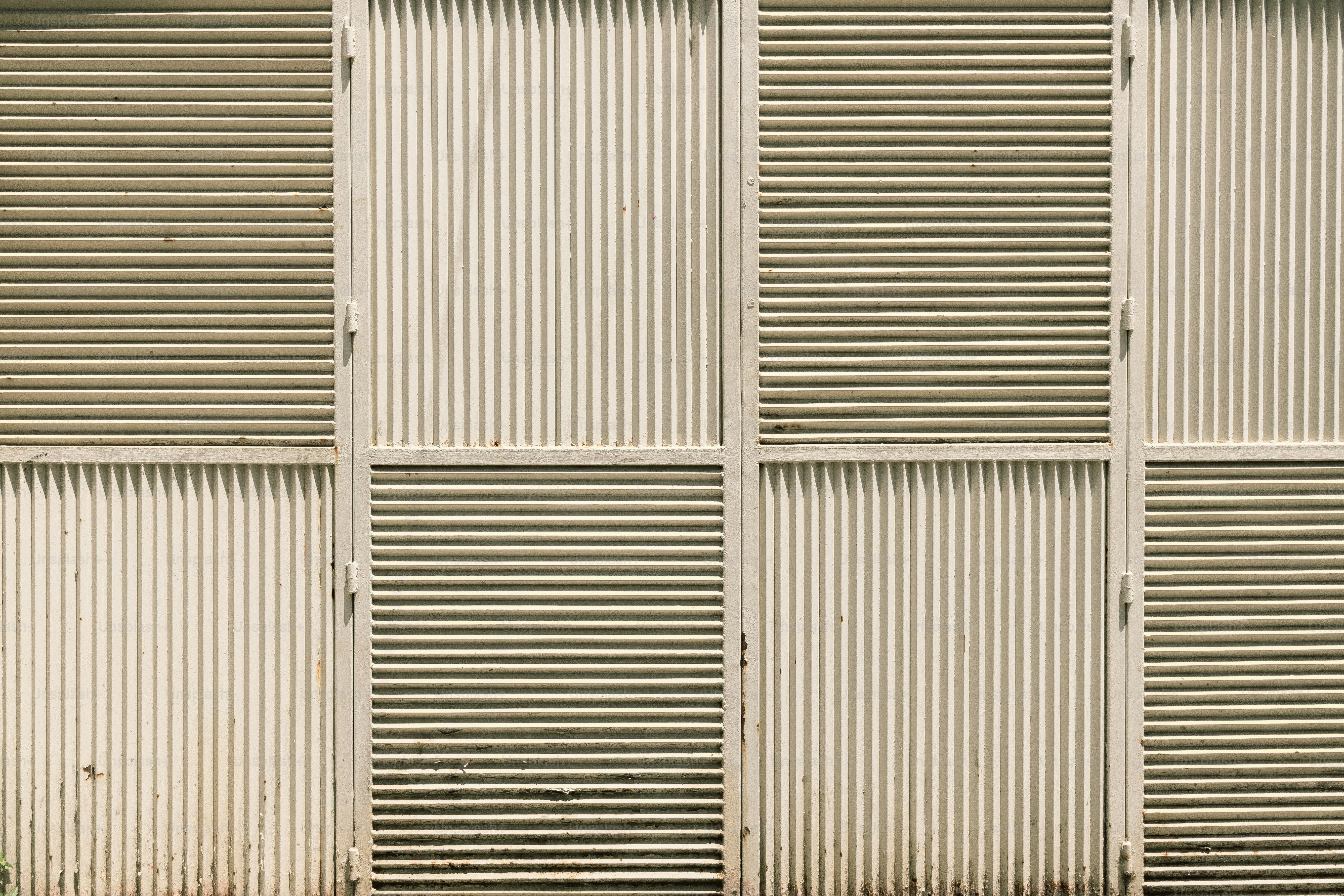 A metal fence with various vertical and horizontal panels. photo ...