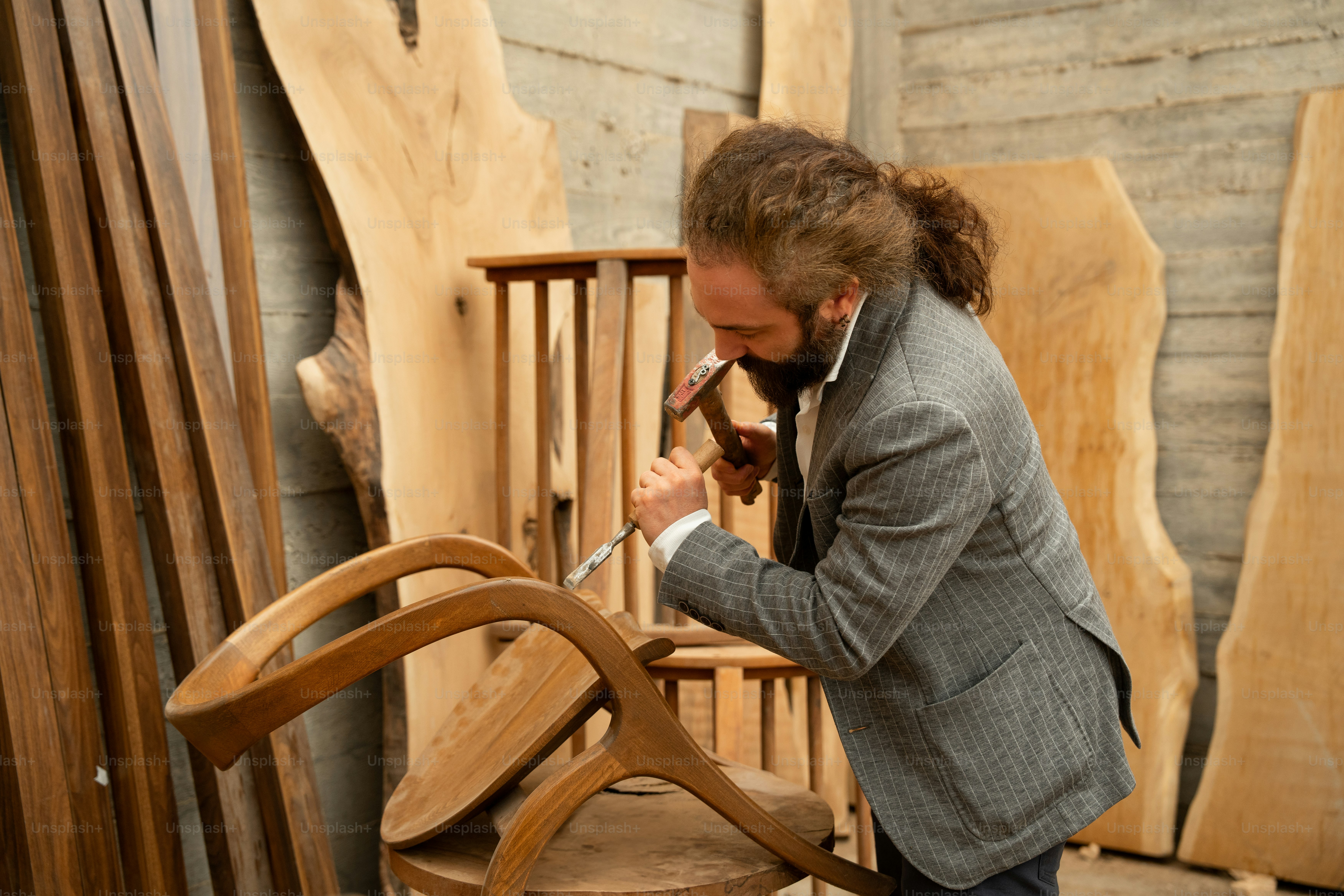 A carpenter skillfully works on a wooden chair. photo – Luxury Image on ...