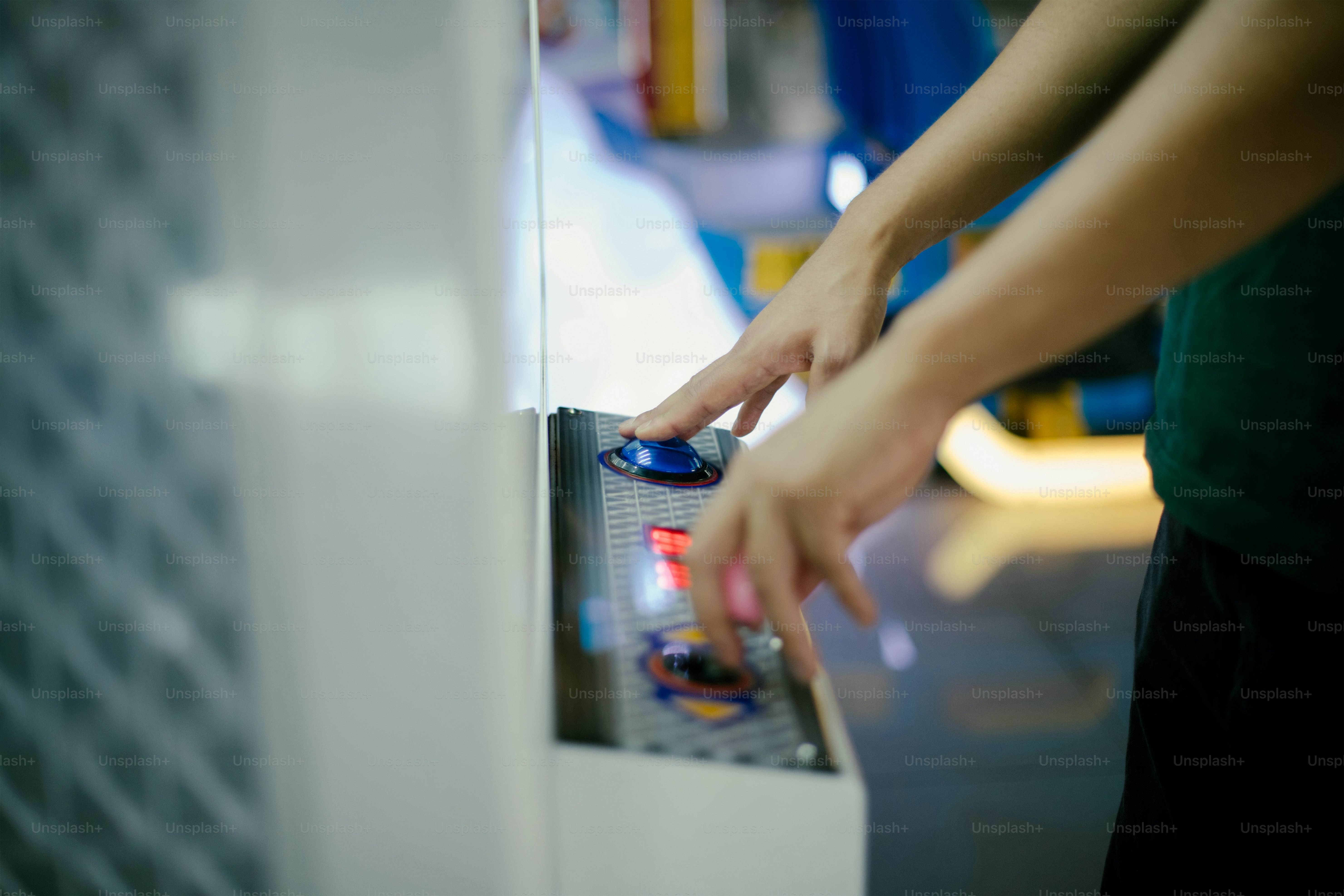 Someone's hands are touching buttons on a machine. photo – Gaming Image ...
