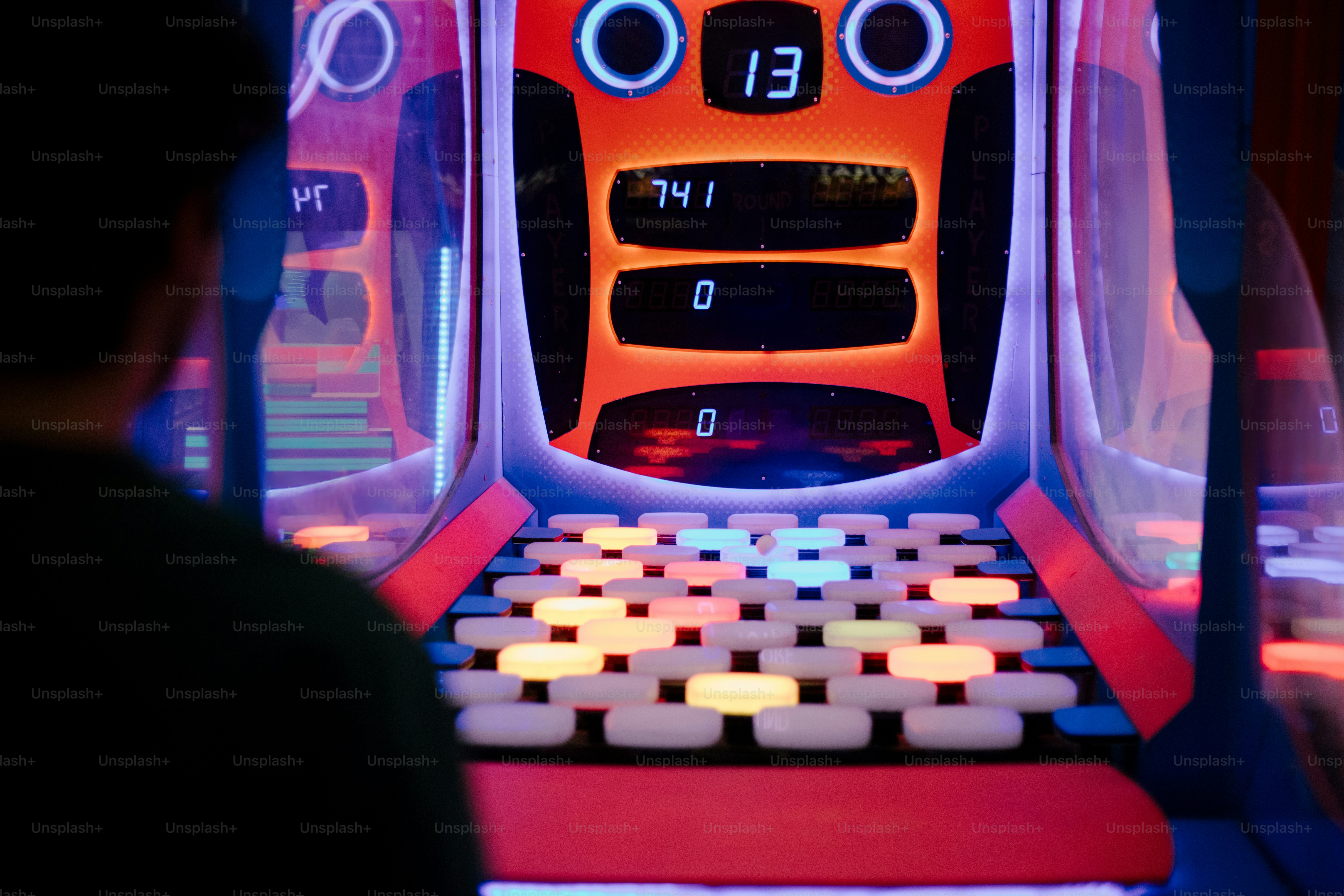 A person plays a colorful arcade game. photo – Gaming Image on Unsplash