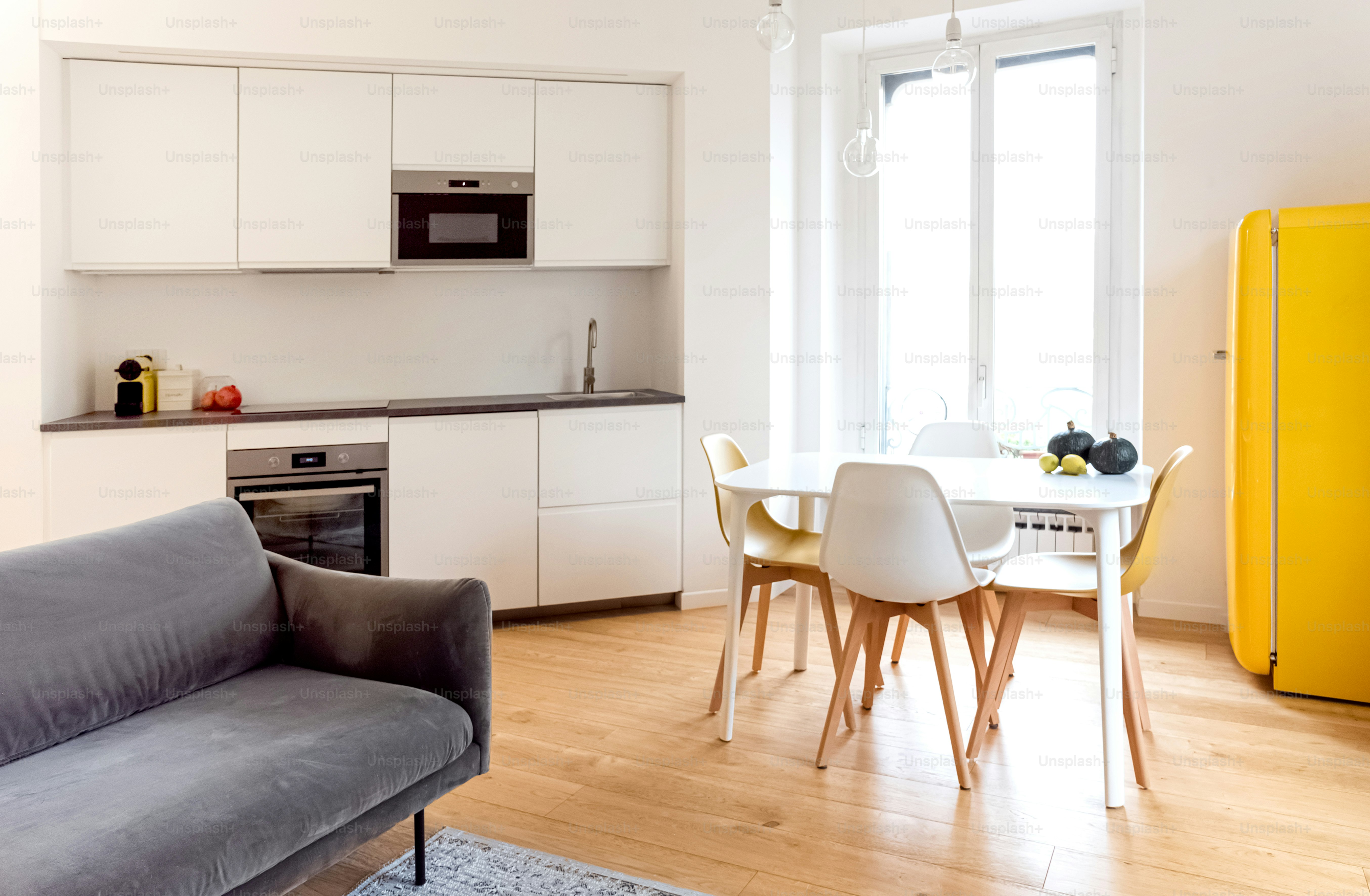 Modern kitchen and dining area with a sunny yellow fridge. photo ...