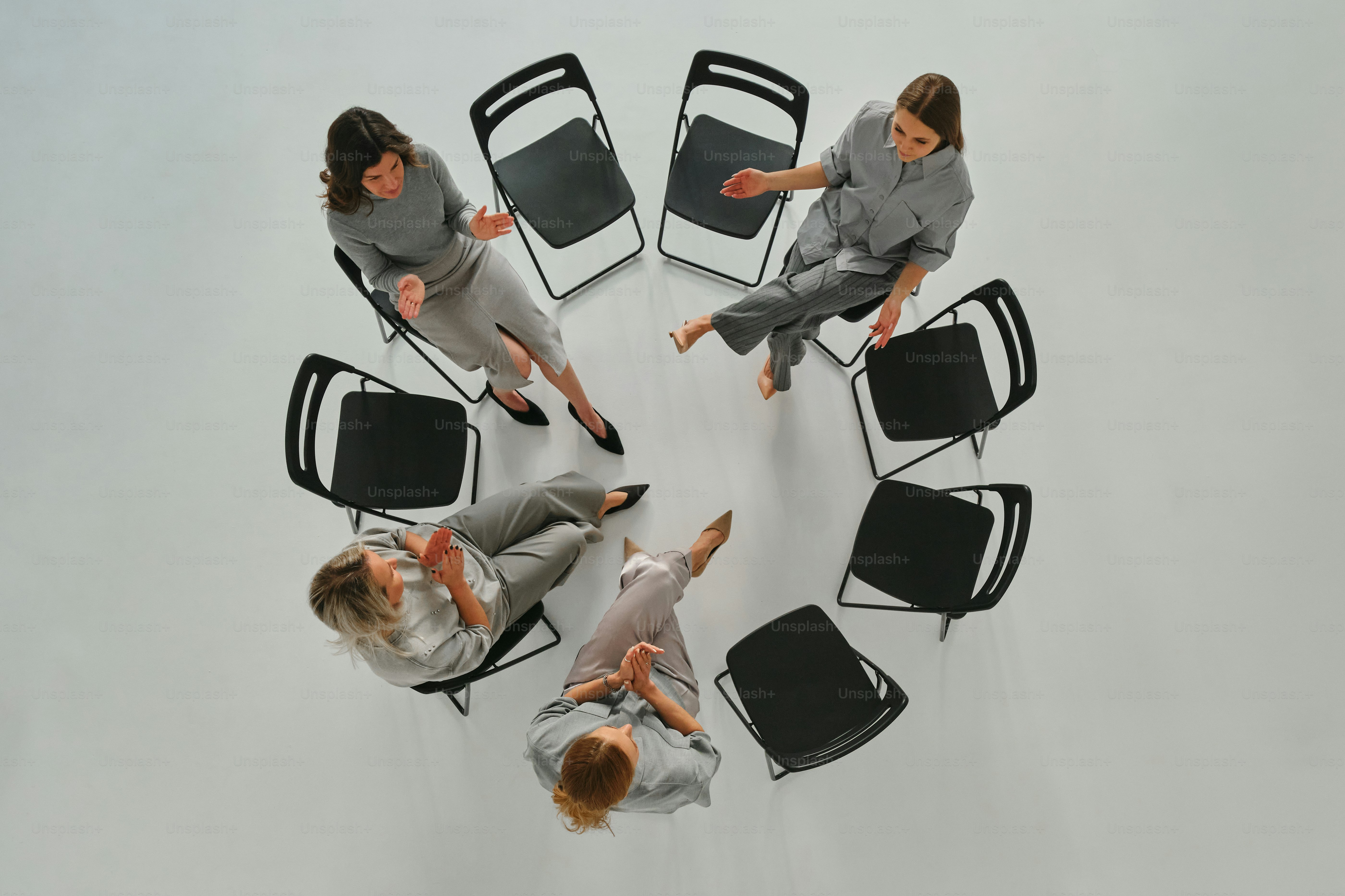 Women sit in a circle in an office setting. photo – Teamwork Image on ...
