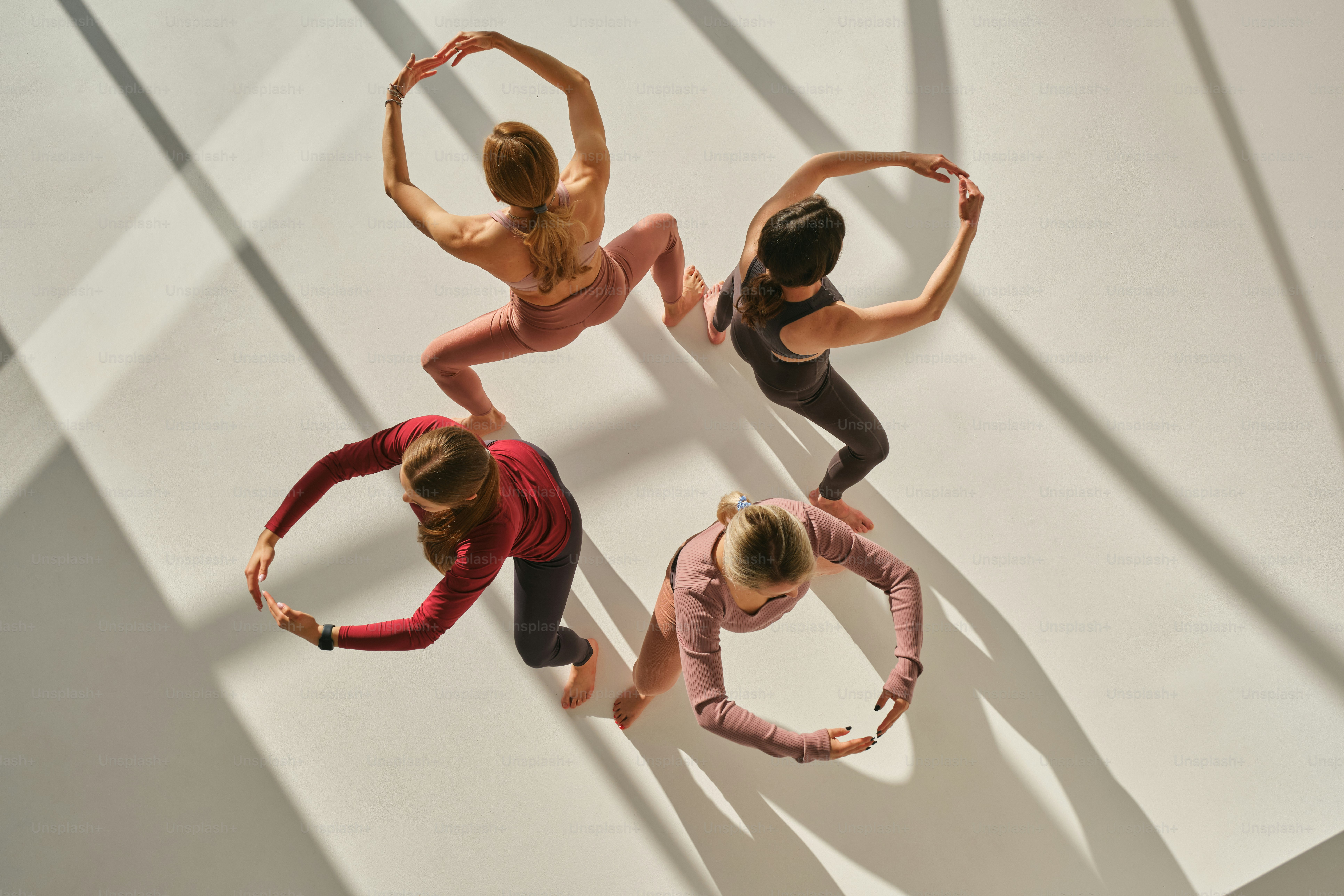 Four dancers form a circle. photo – Women Image on Unsplash