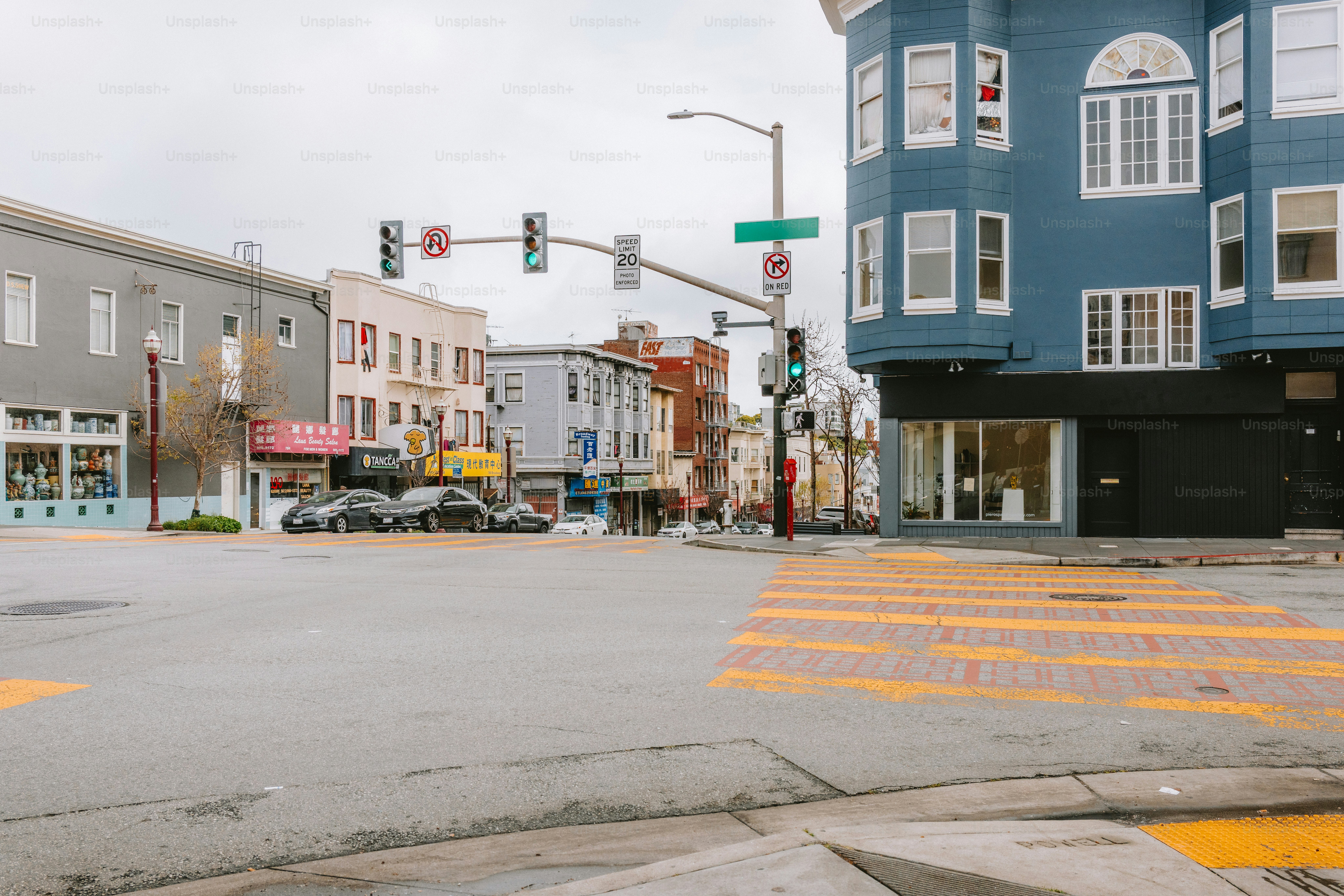 A city street corner with buildings and traffic lights. photo – City ...