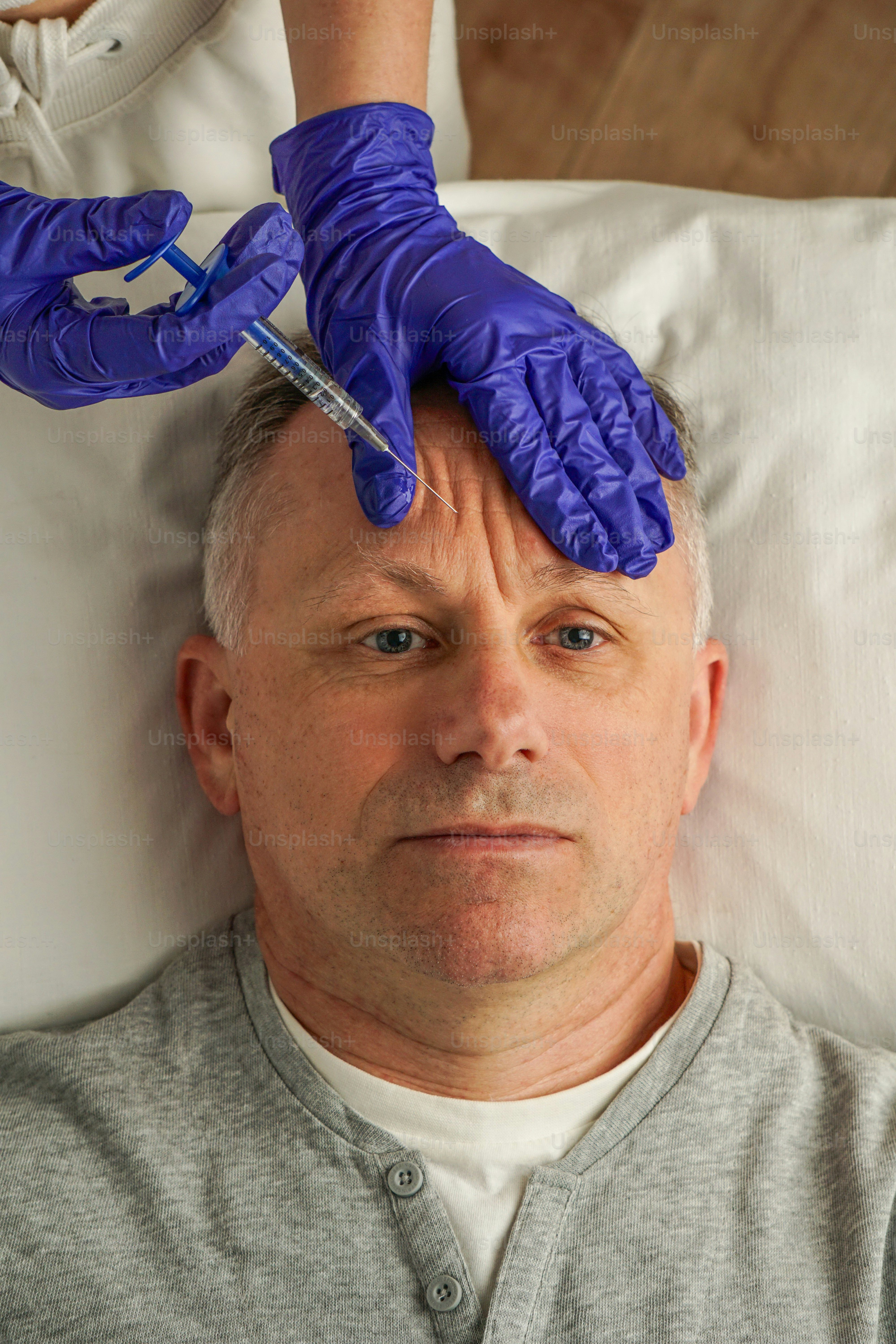 A man receives a botox injection. photo – Health Image on Unsplash