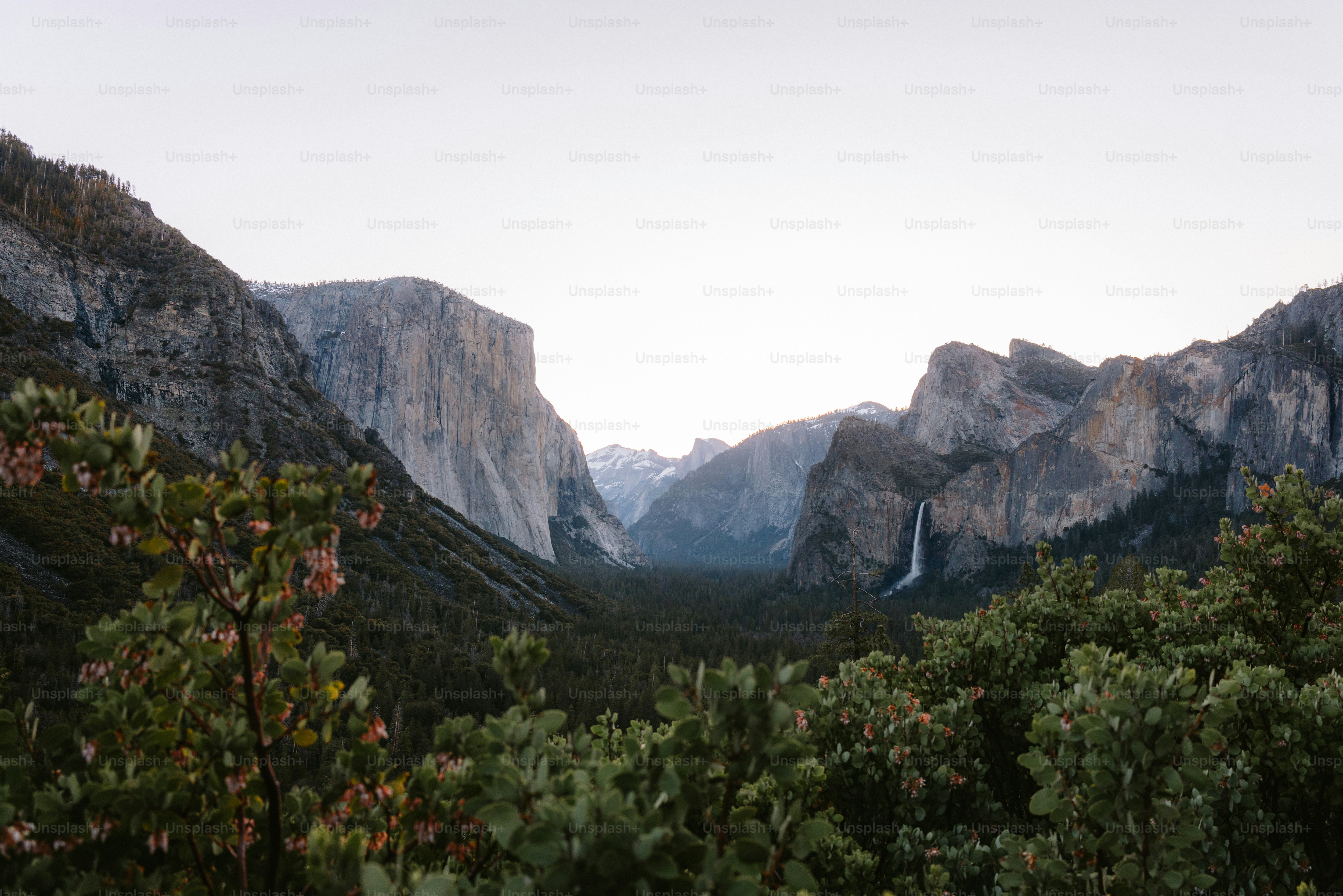 Mountains and greenery frame a scenic, open valley. photo – Waterfall ...
