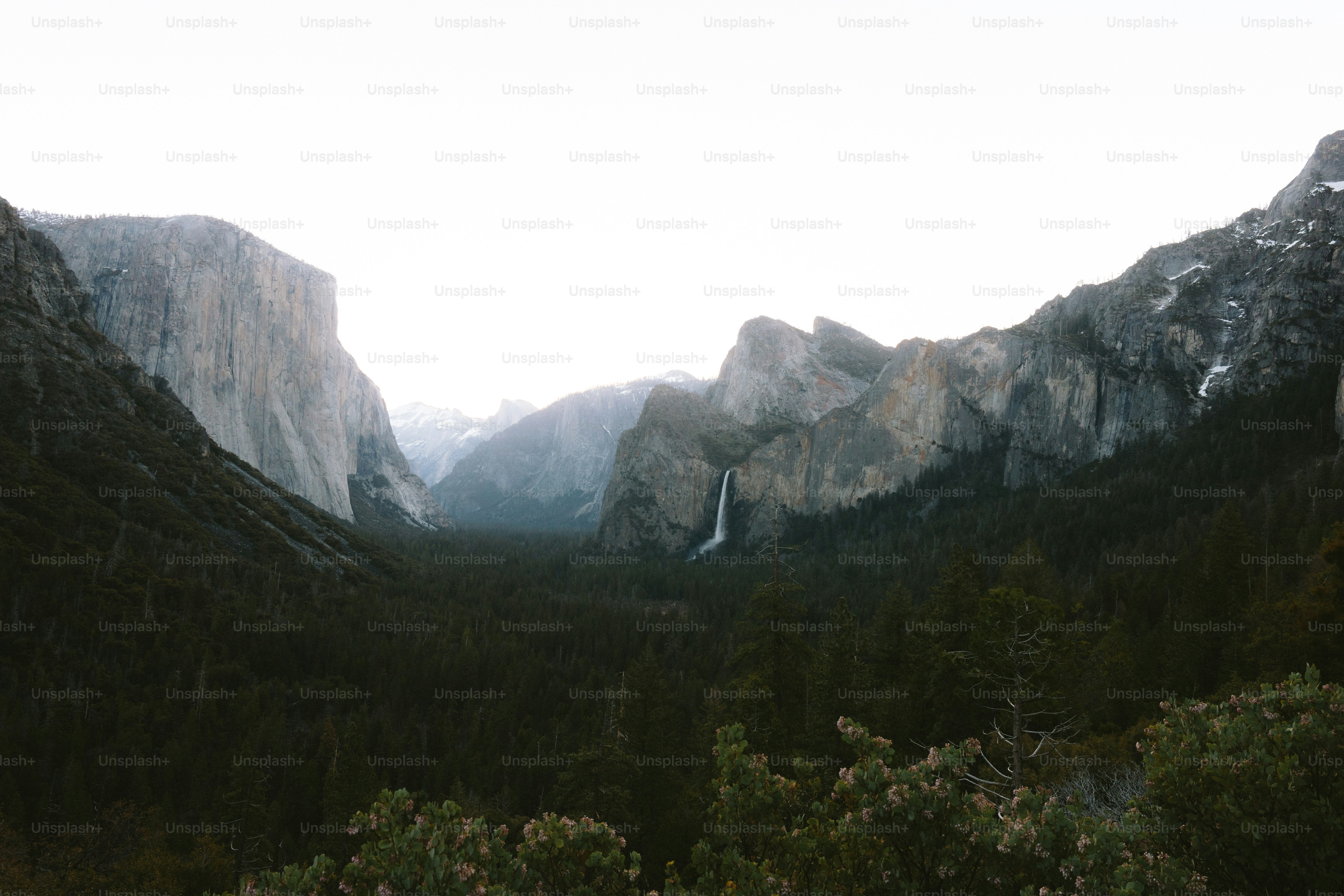 Majestic mountains surround a valley and waterfall. photo – Waterfall ...