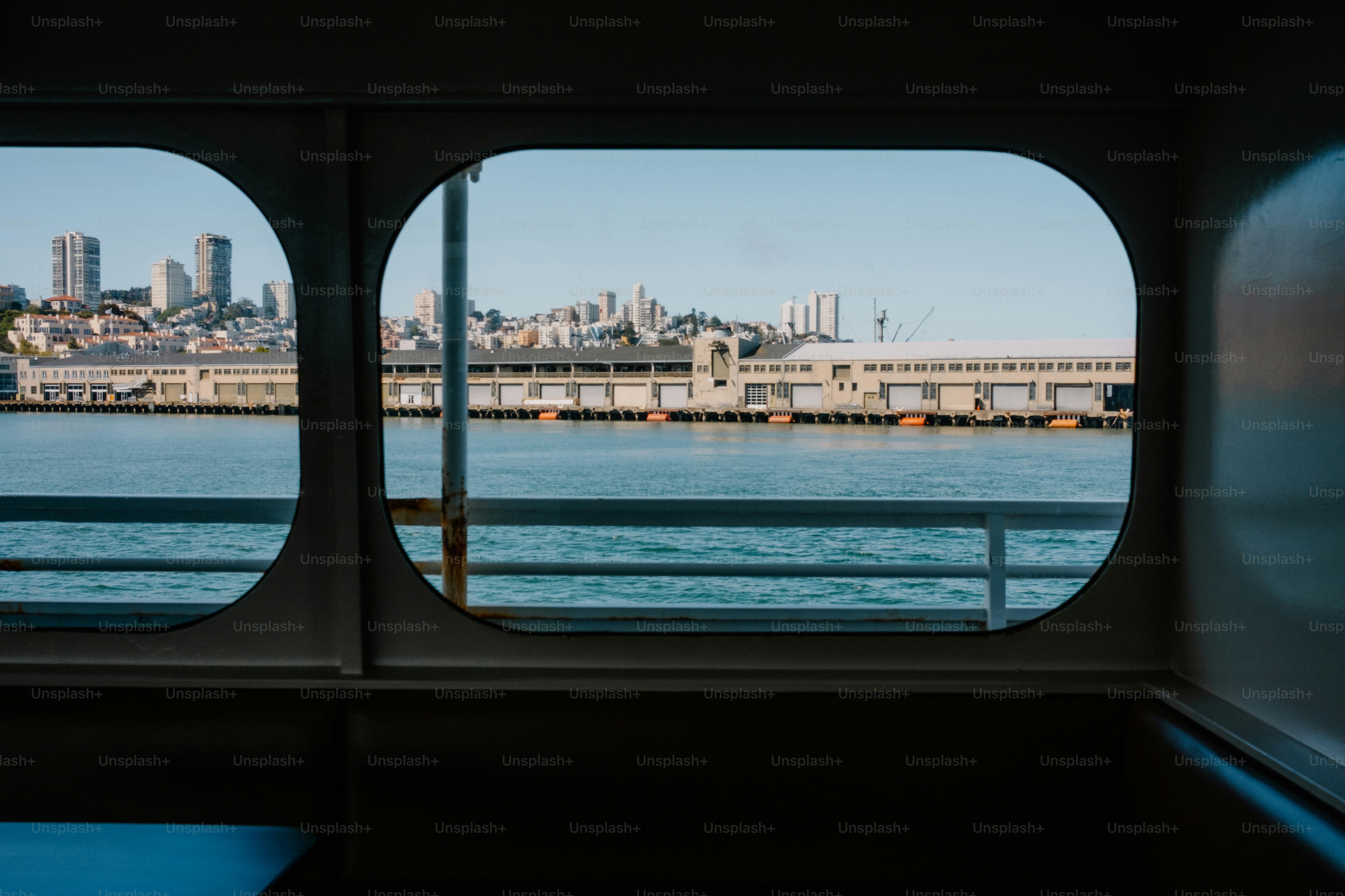 A cityscape seen through ferry windows. photo – Background Image on ...