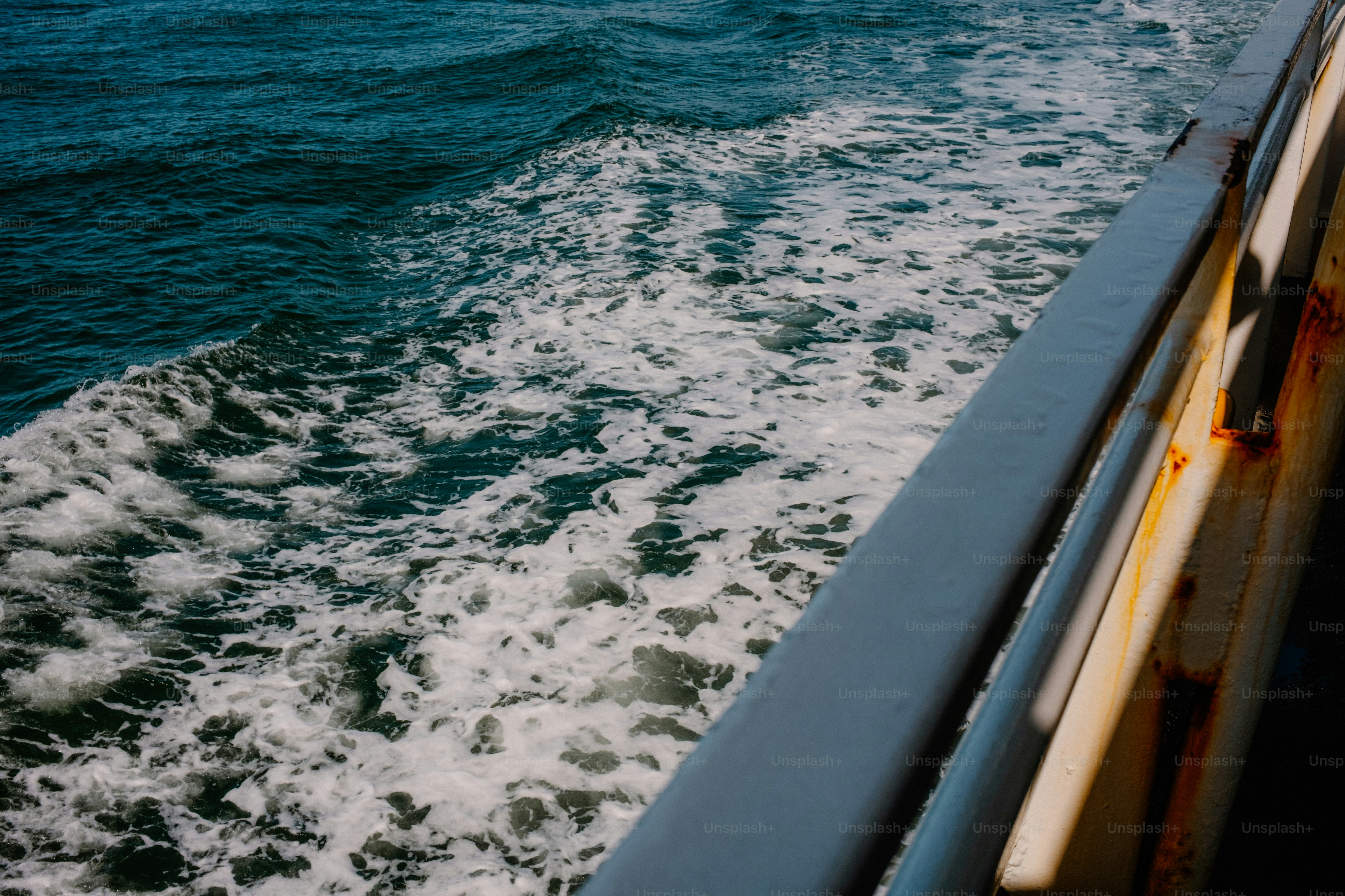 Boat's wake creates foamy waves on the water. photo – Waves Image on ...