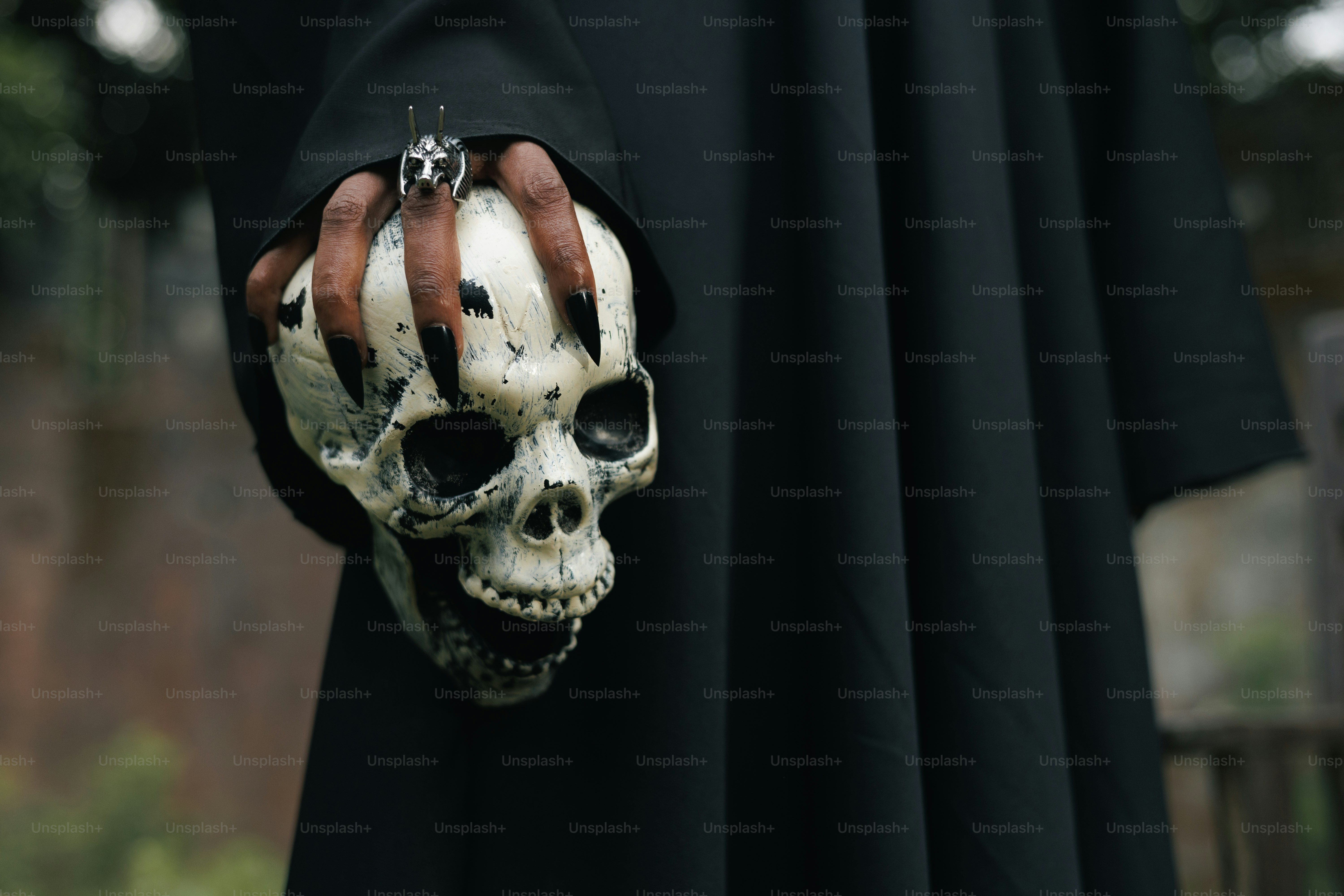 La parca sostiene una calavera. foto – Imagen de Mujer en Unsplash