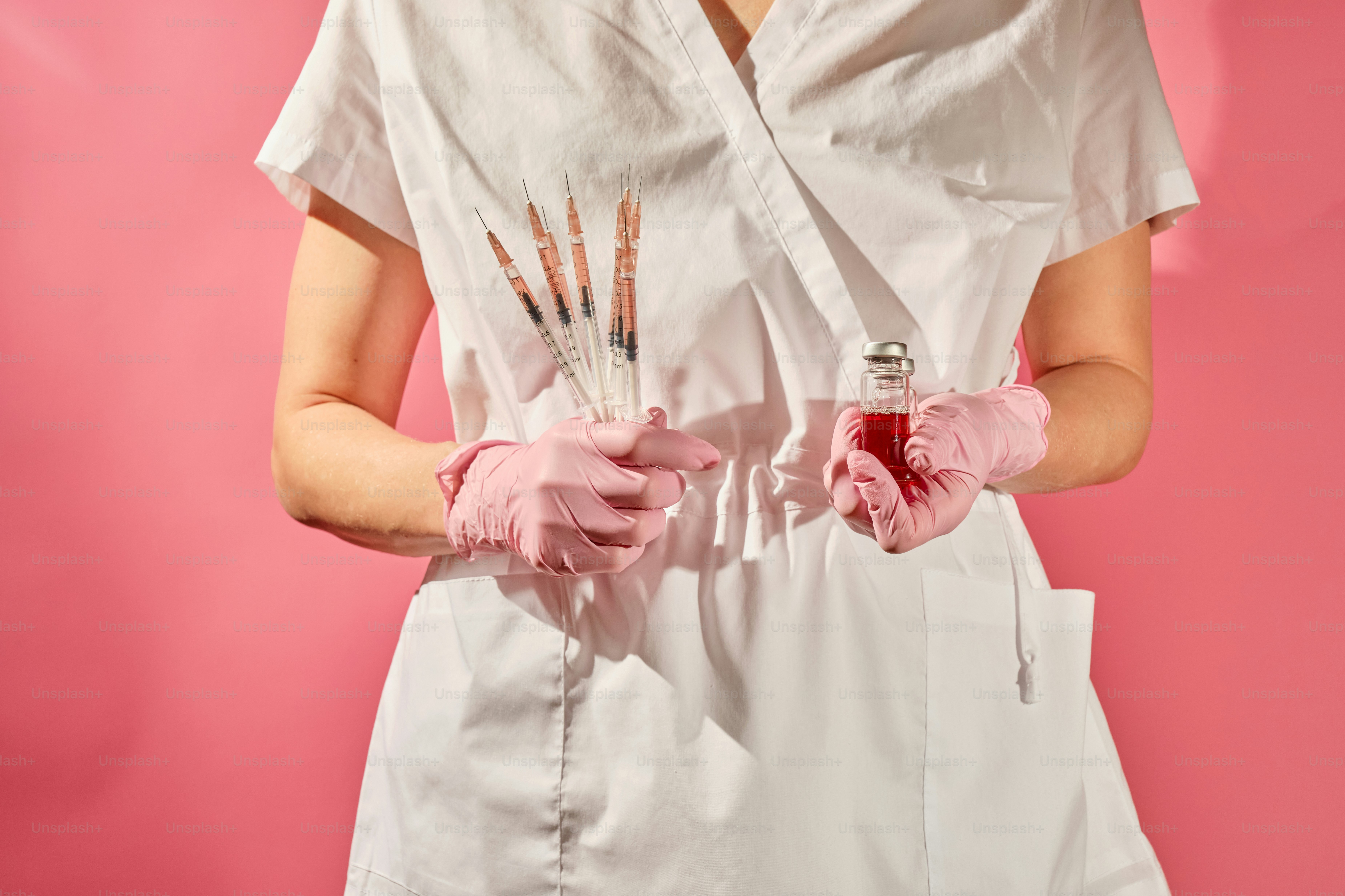 A person holds syringes and a vial of fluid. photo – Health Image on ...