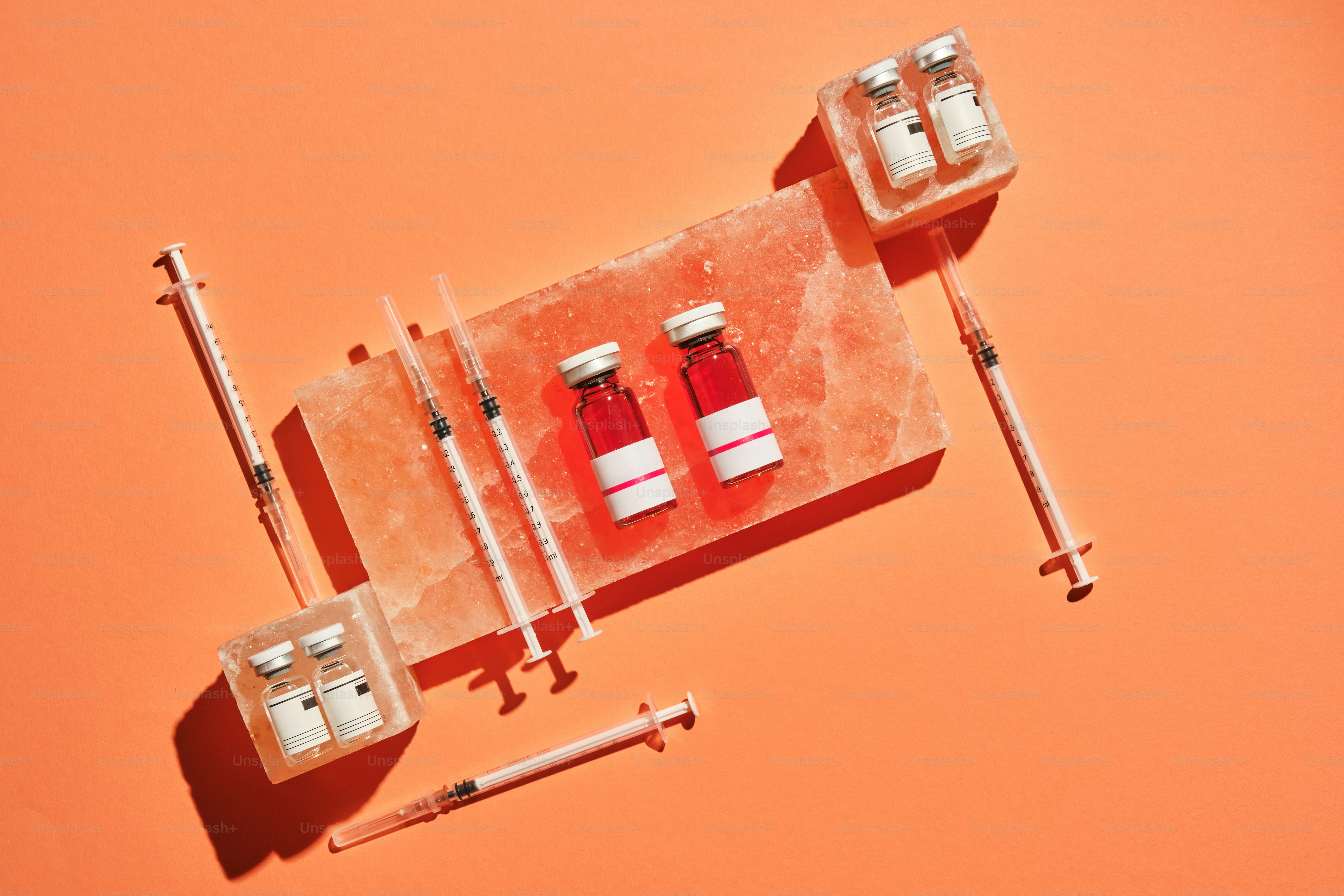 Vaccines and syringes are arranged on an orange surface. photo – Health ...