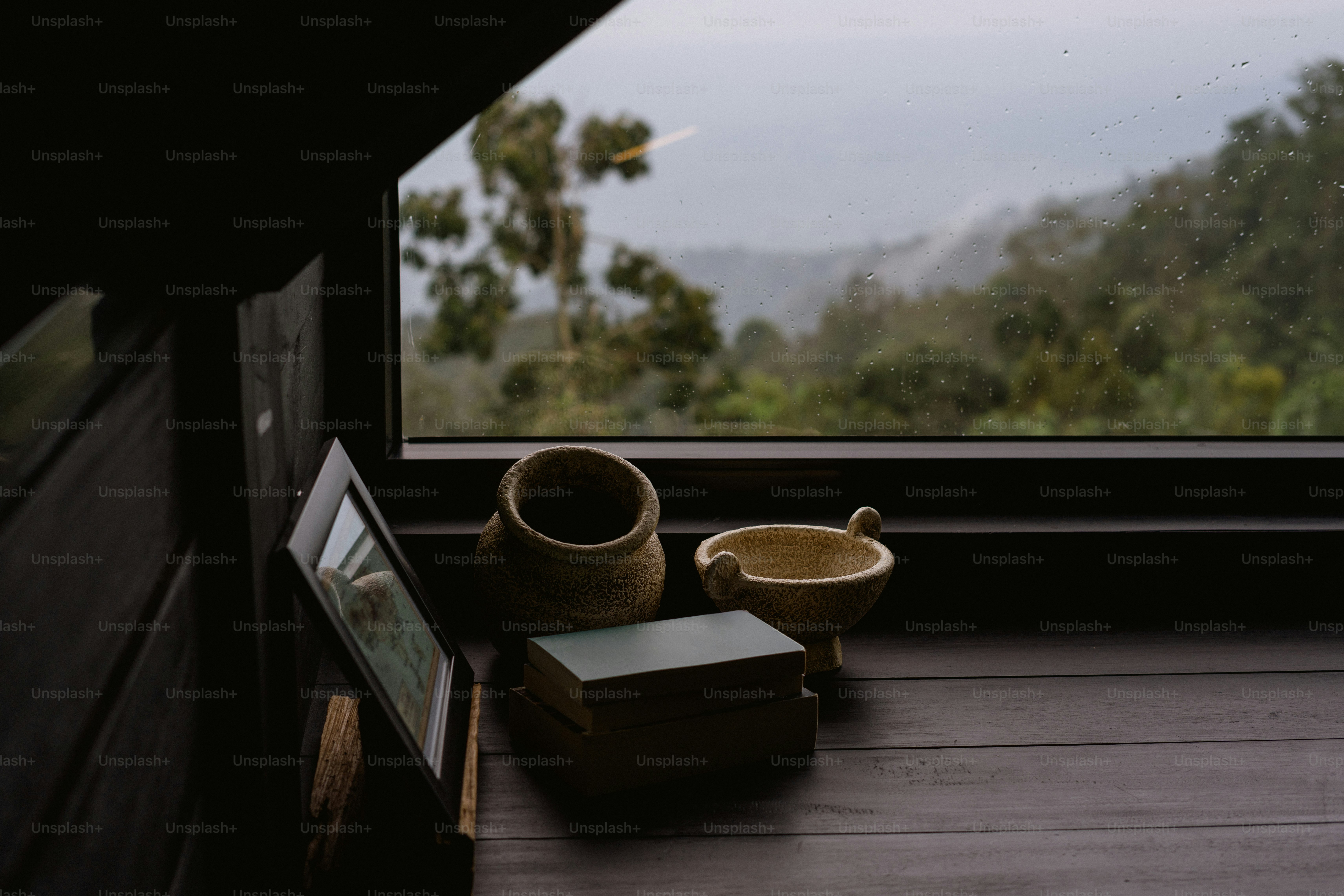 Objects sit near a window overlooking a misty landscape. photo – Travel ...