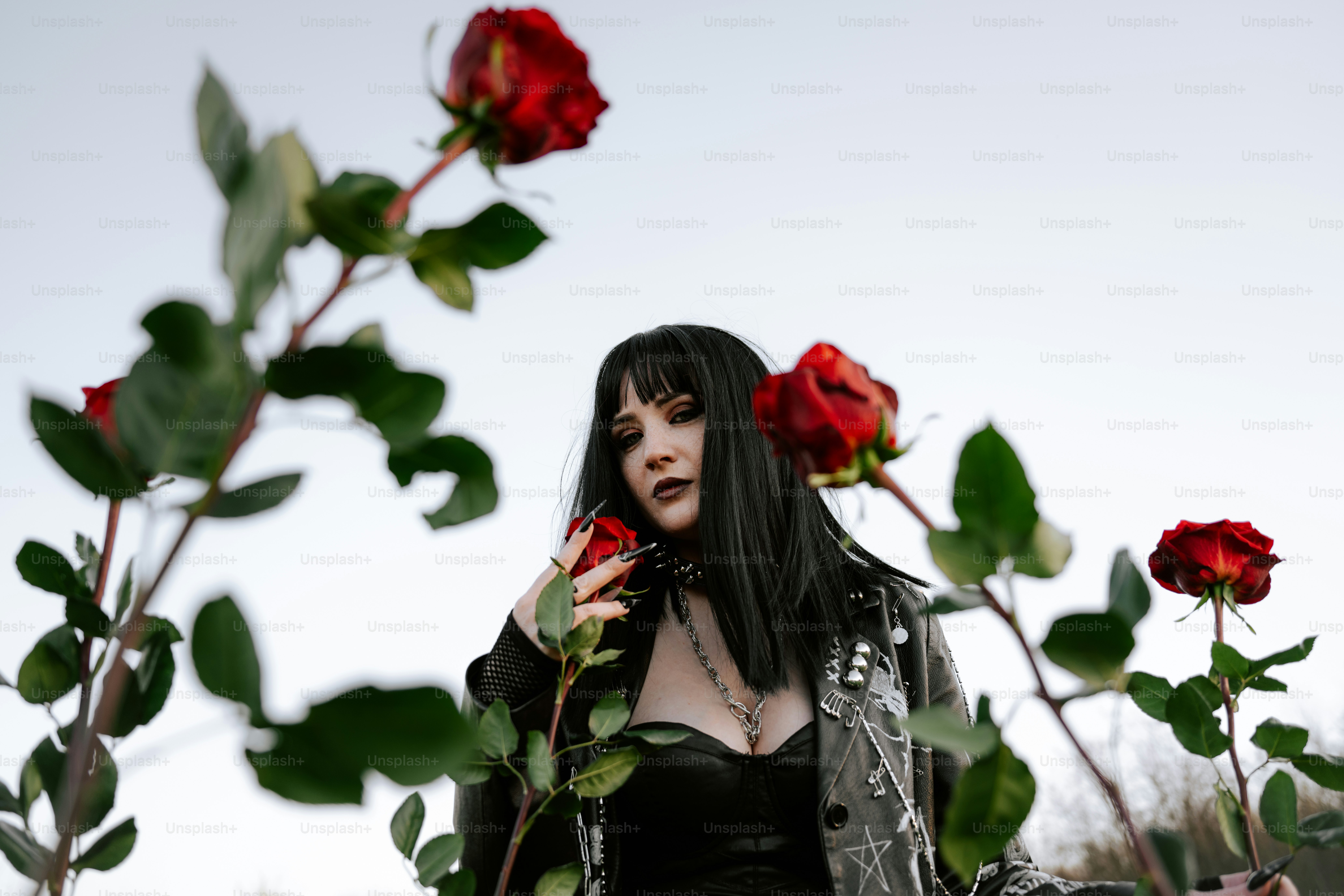 A woman poses with red roses. photo – Image on Unsplash