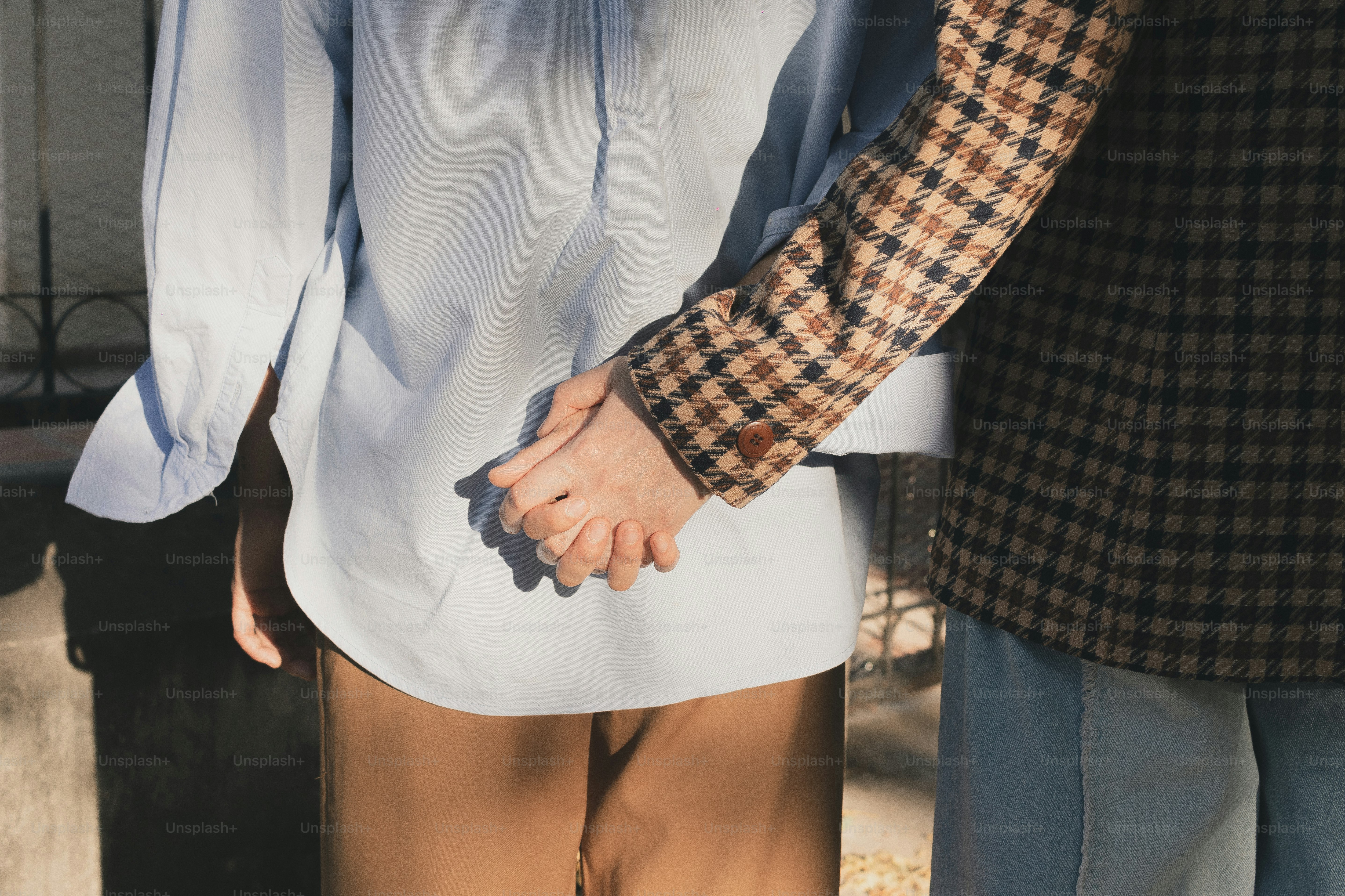 Two people hold hands, standing together. photo – Portrait Image on ...
