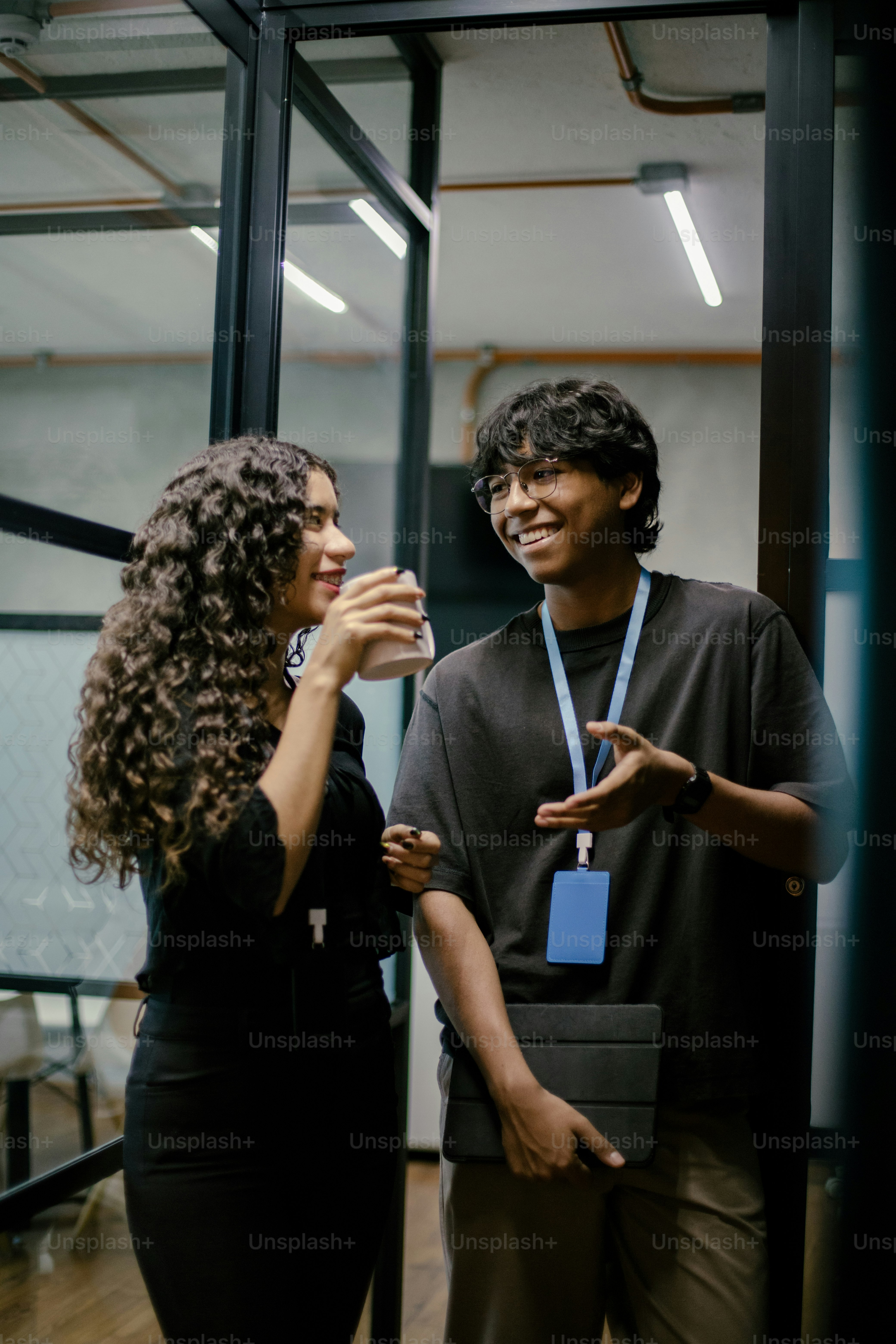 Coworkers share a friendly moment at work. photo – Team Image on Unsplash