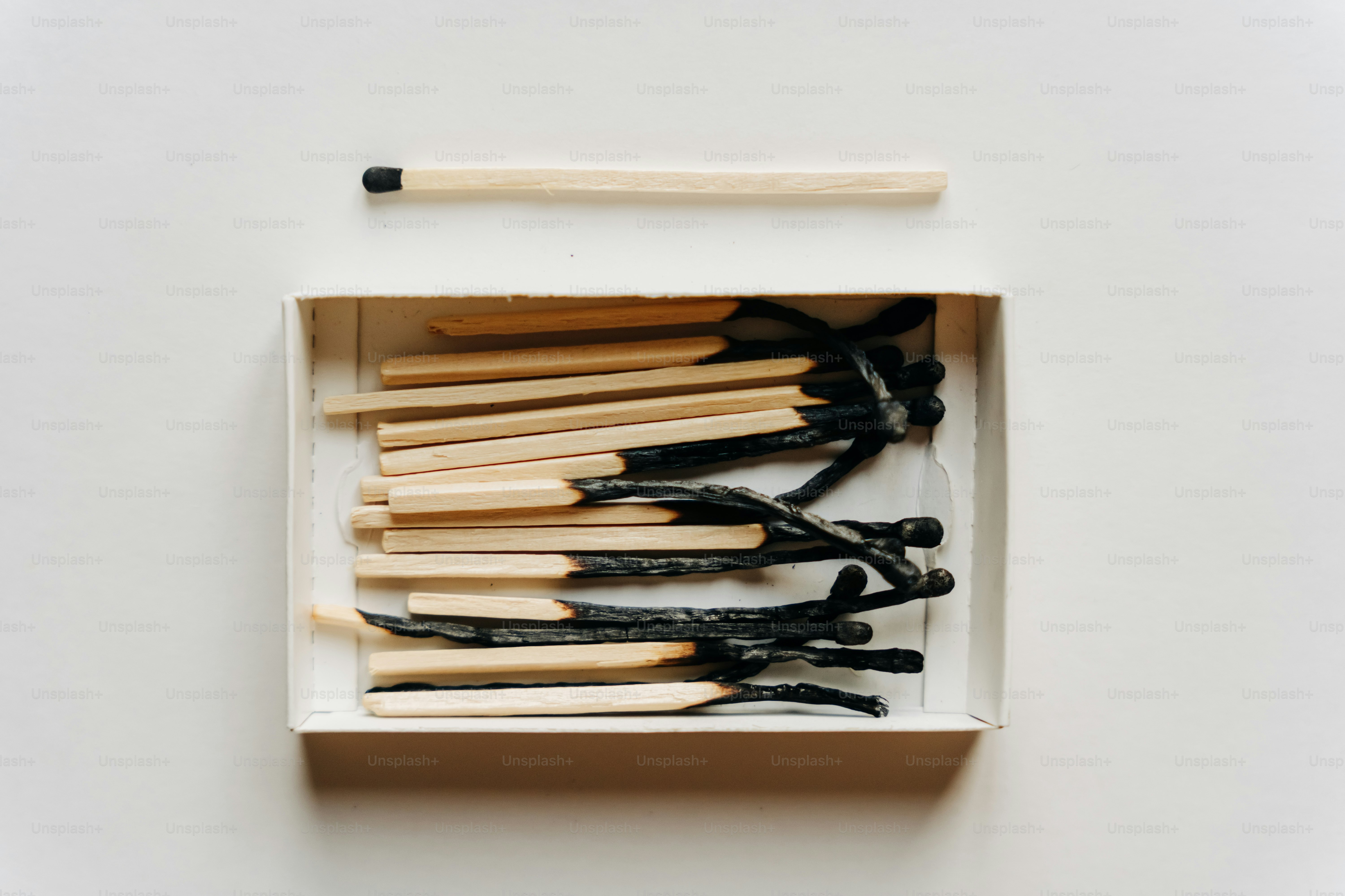 A matchbox with burnt and unburnt matches. photo – Burnout Image on ...