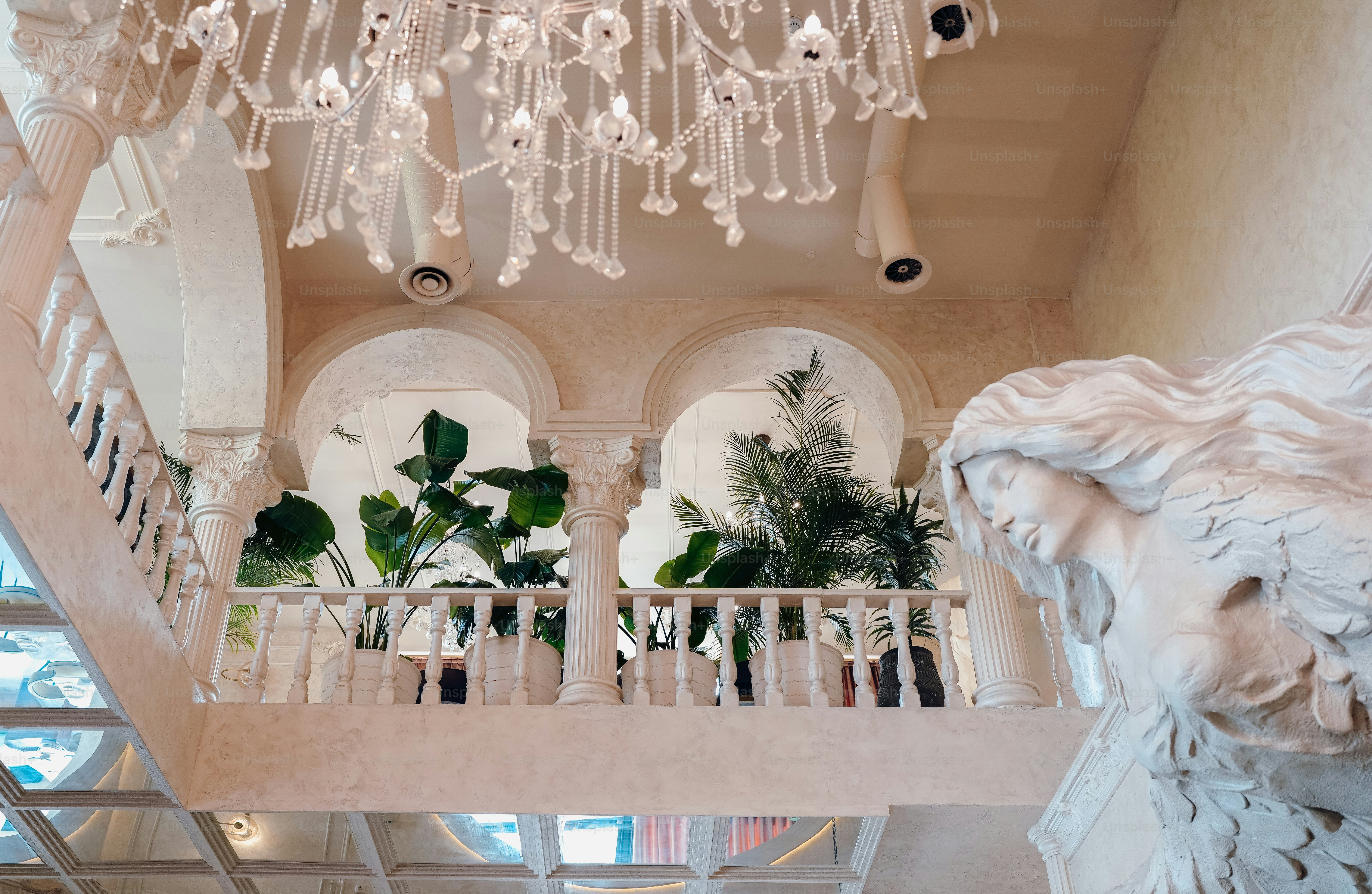 A fancy interior with columns and a chandelier. photo – Luxury Image on ...