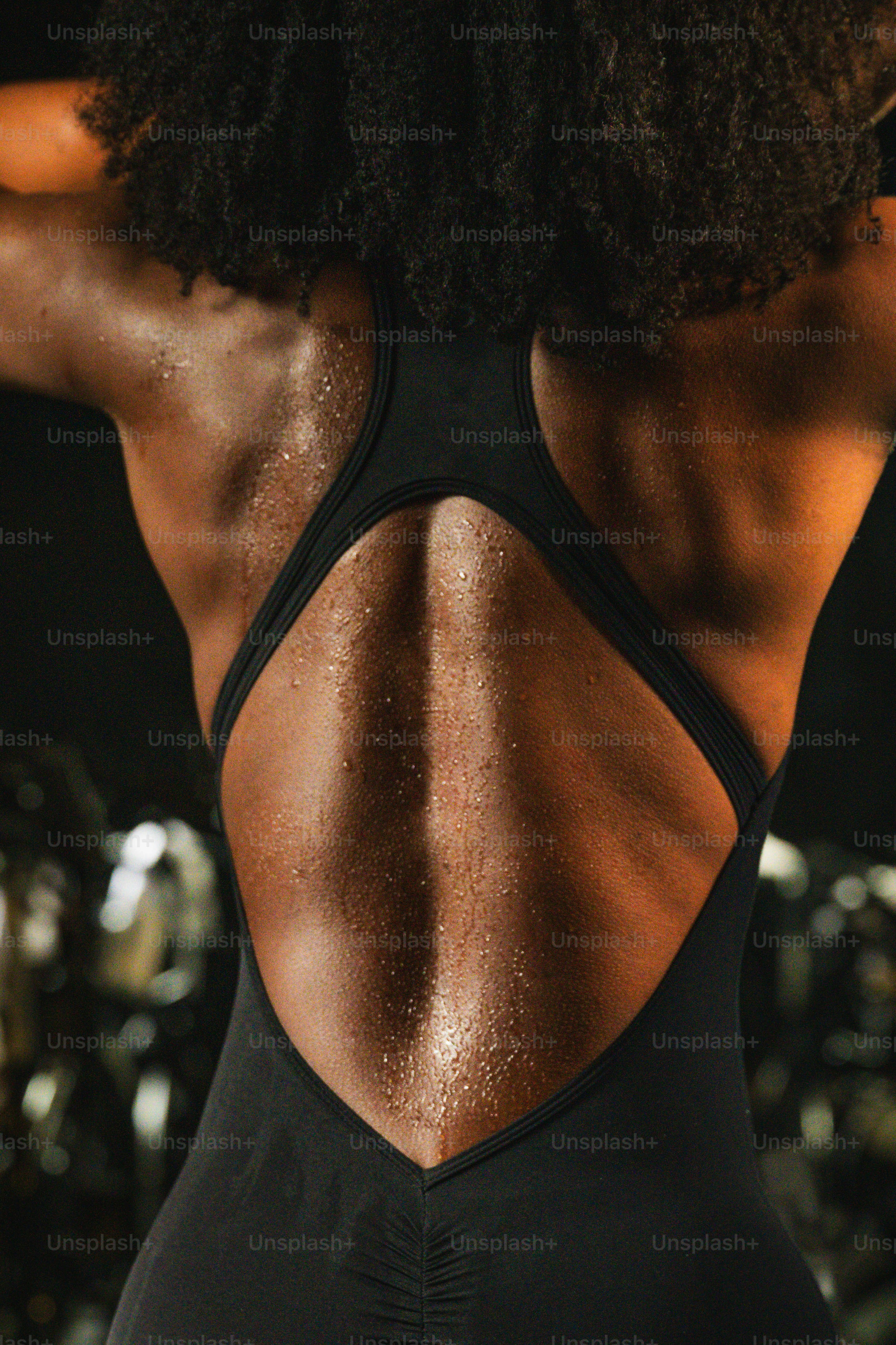 A sweaty back displays after an intense workout. photo – Exercise Image ...