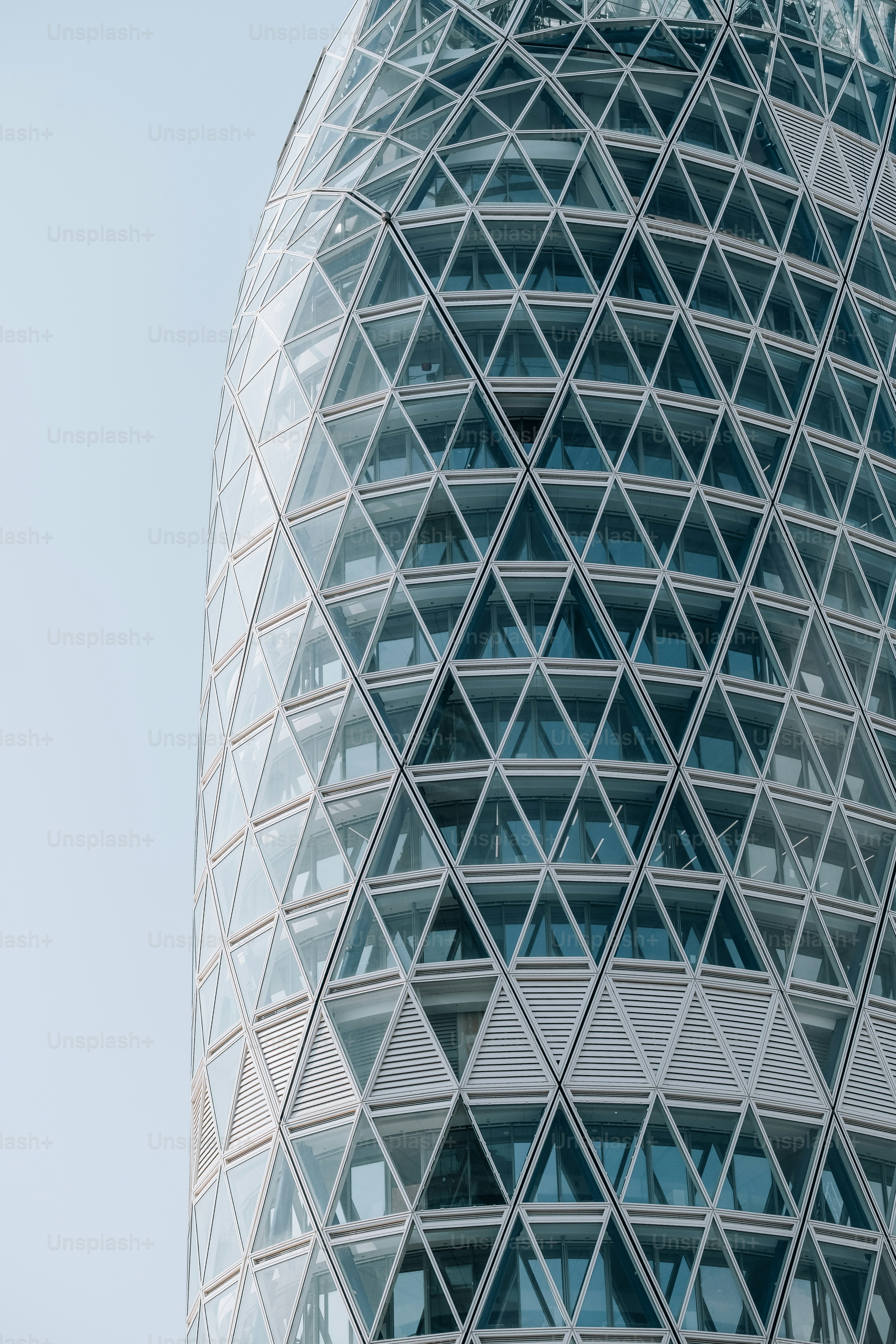 A modern building has a triangular, glass facade. photo – Wallpaper ...