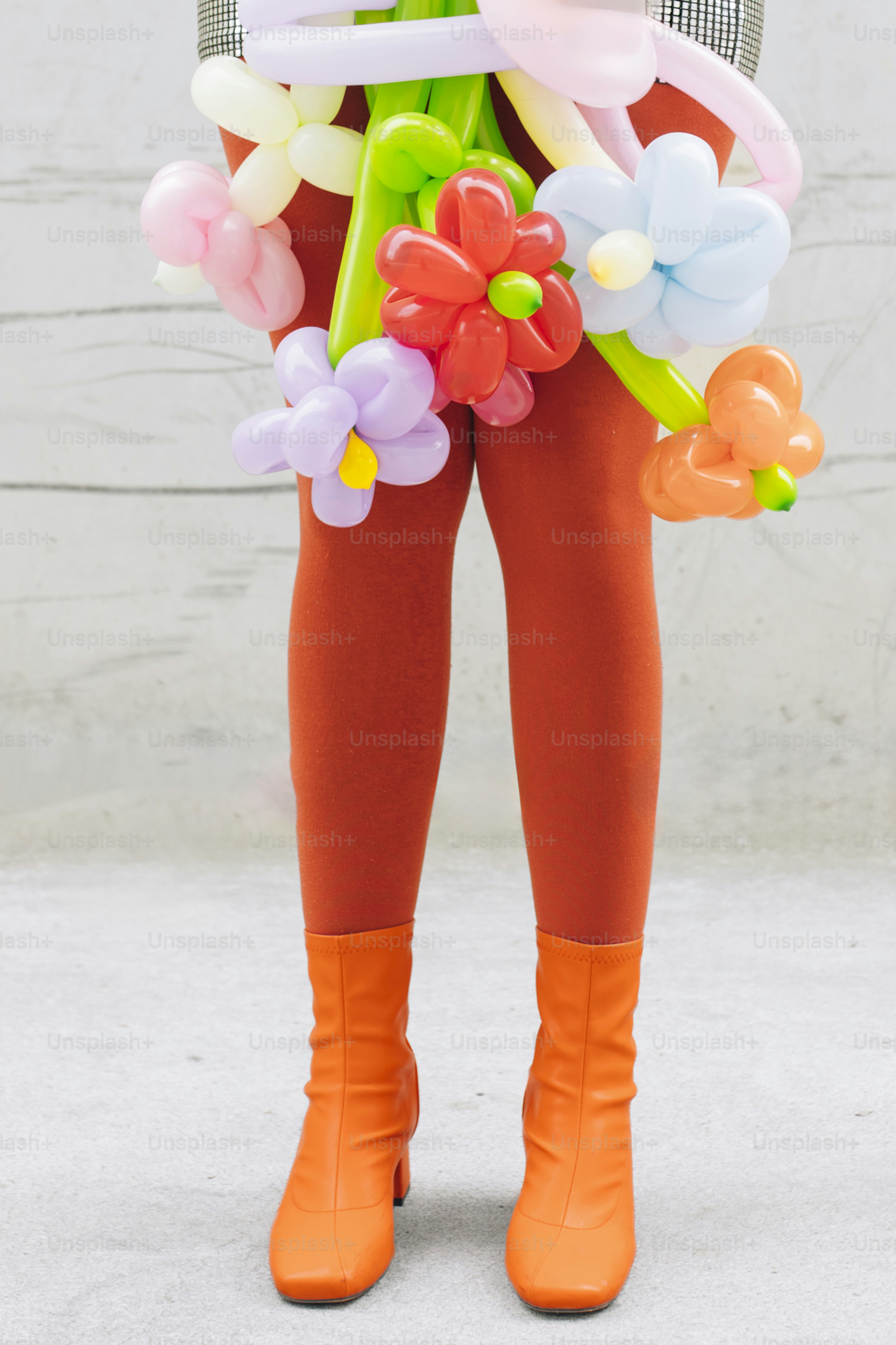 Person's legs with balloon flowers and orange boots. photo ...