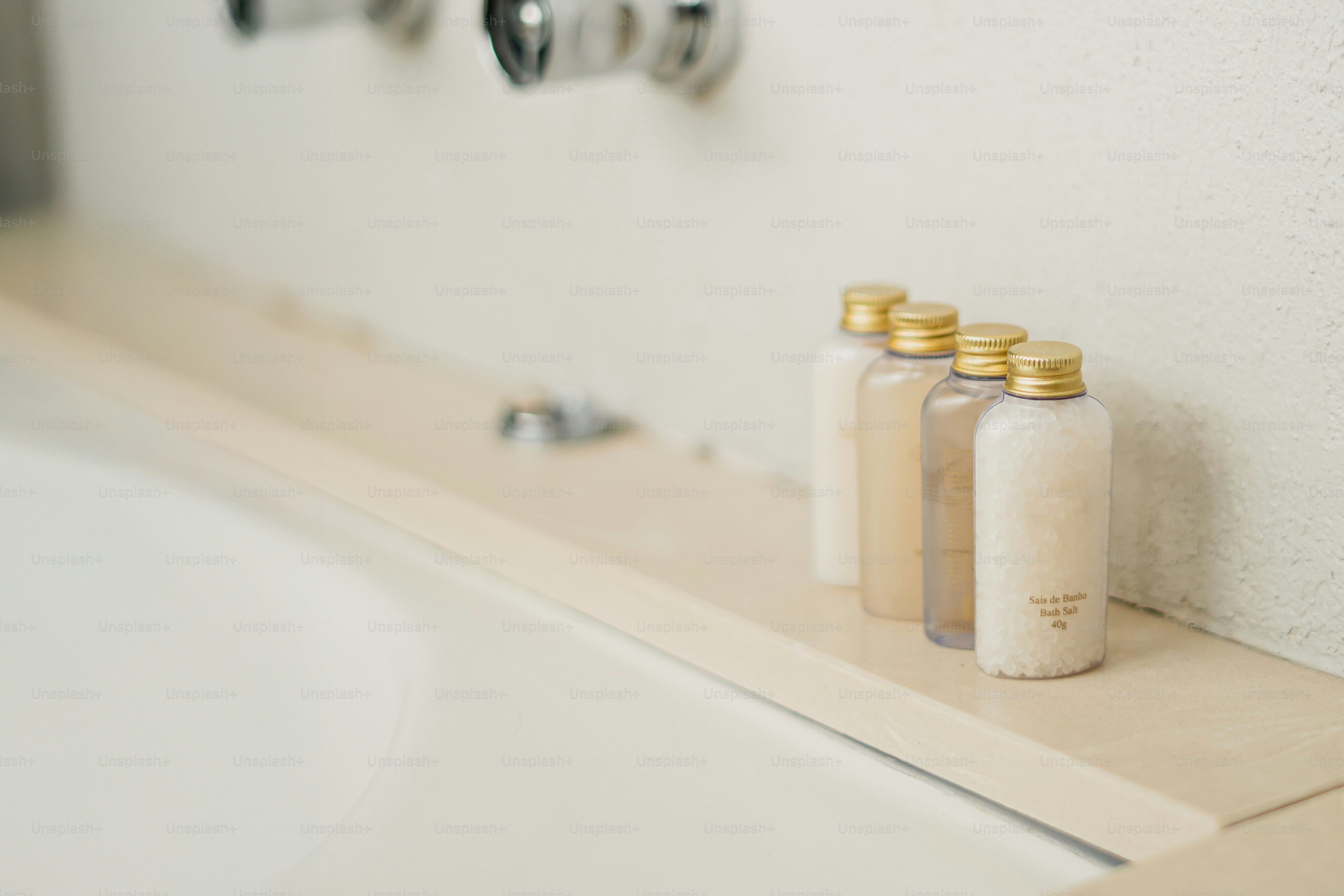 Bottles of toiletries are on a bathtub ledge. photo – Travel Image on ...