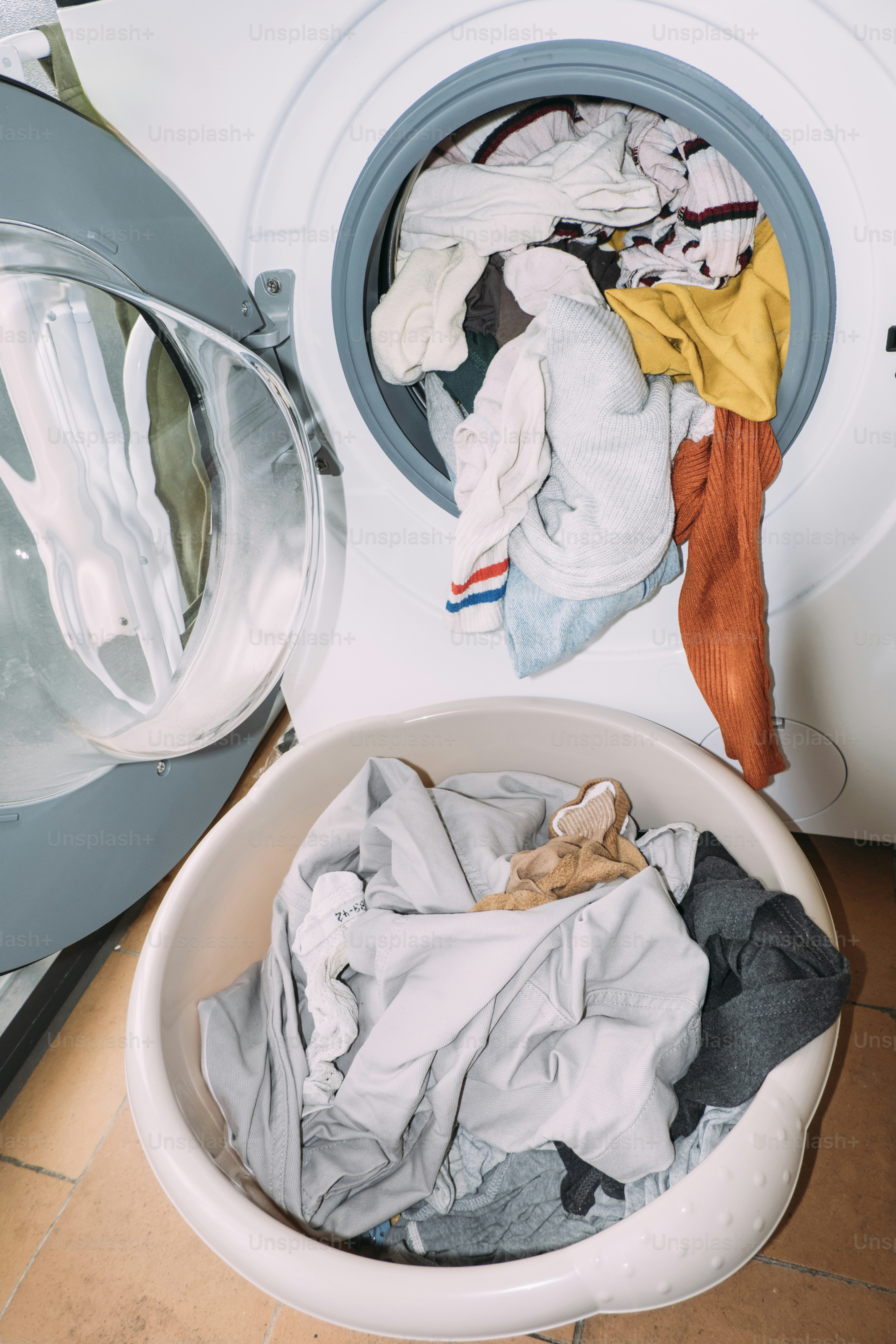 A washing machine is filled with colorful laundry. photo – Laundry ...