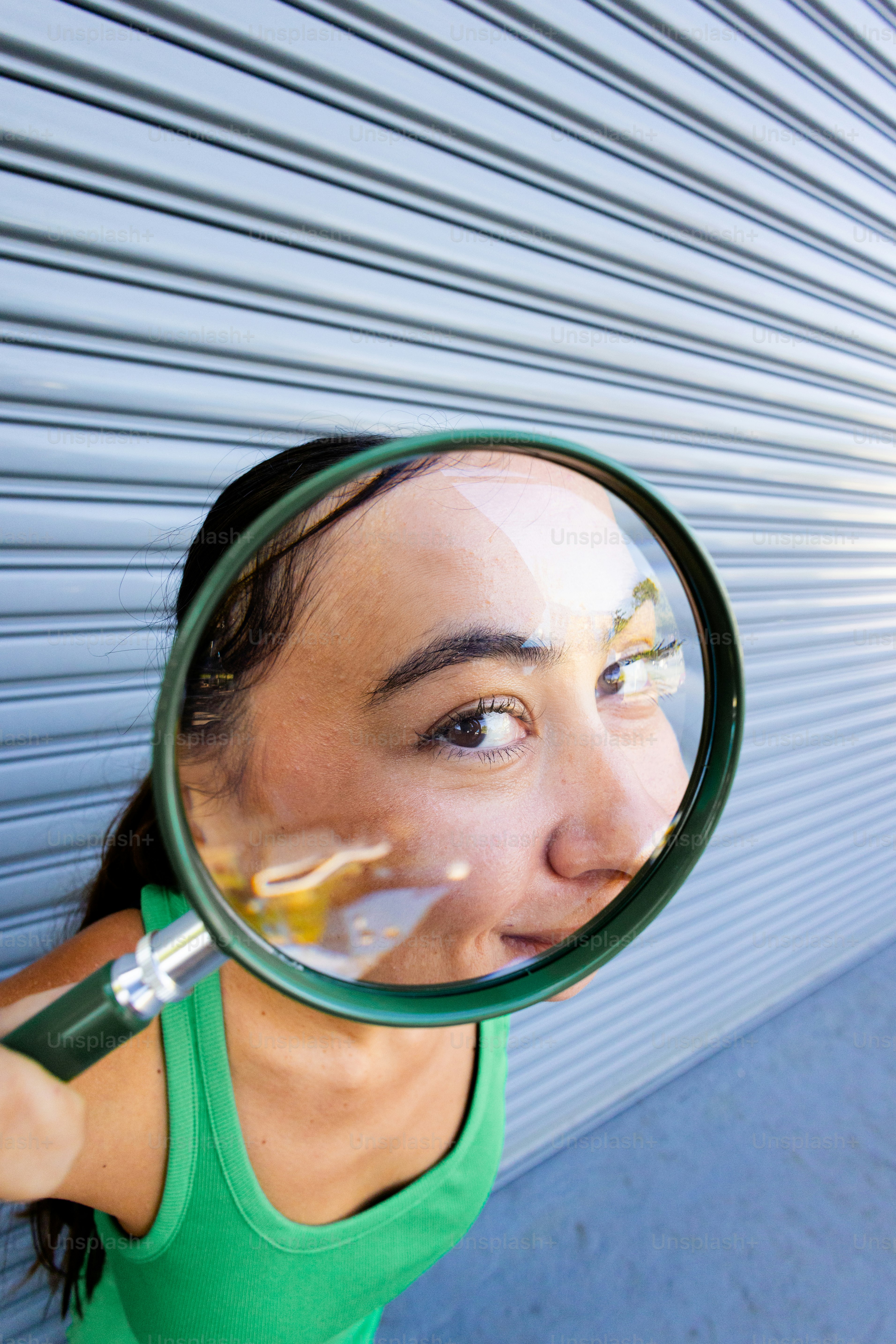 A woman is looking through a magnifying glass. photo – Perspective ...