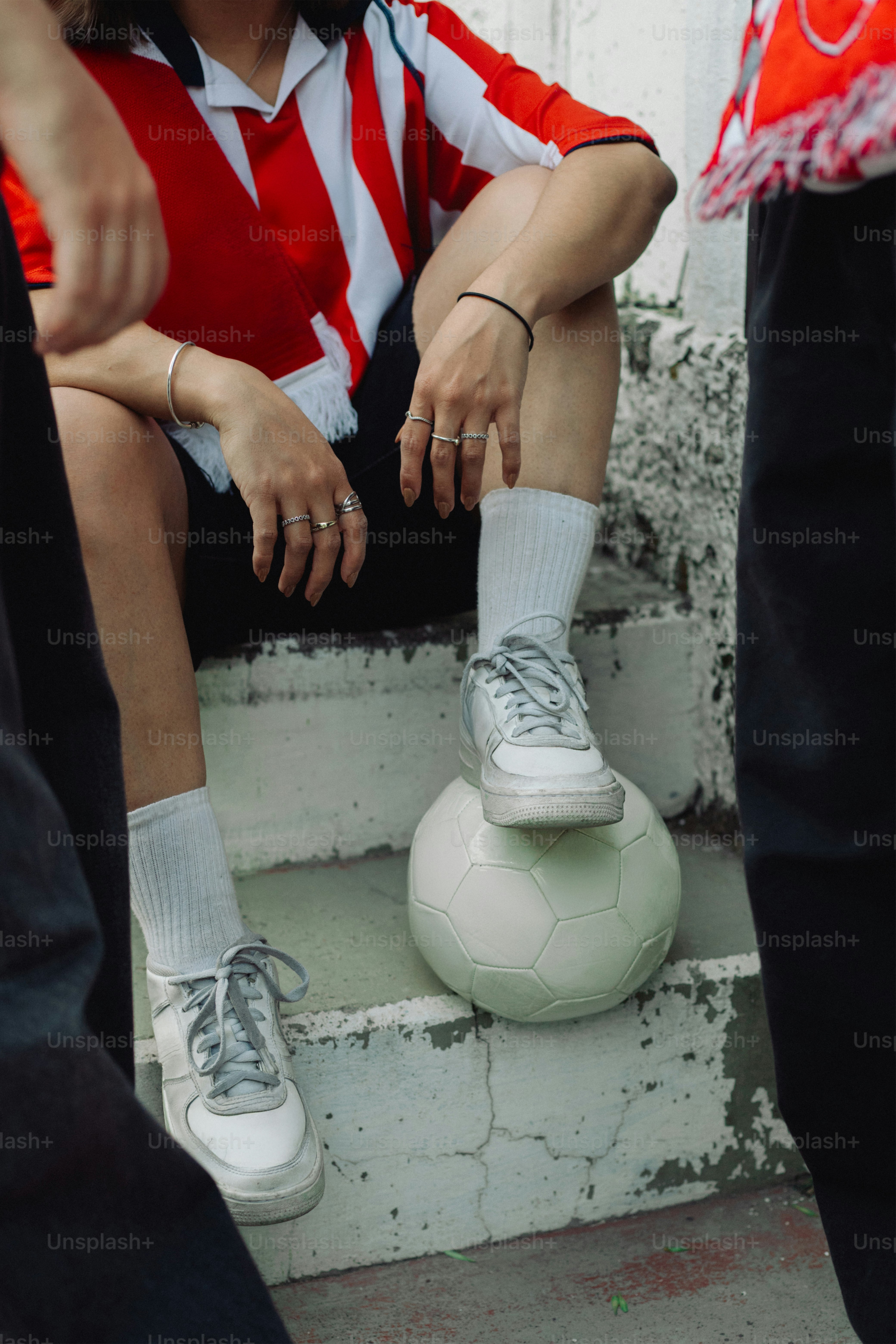 A person holds a soccer ball and a jersey. photo – Red Image on Unsplash