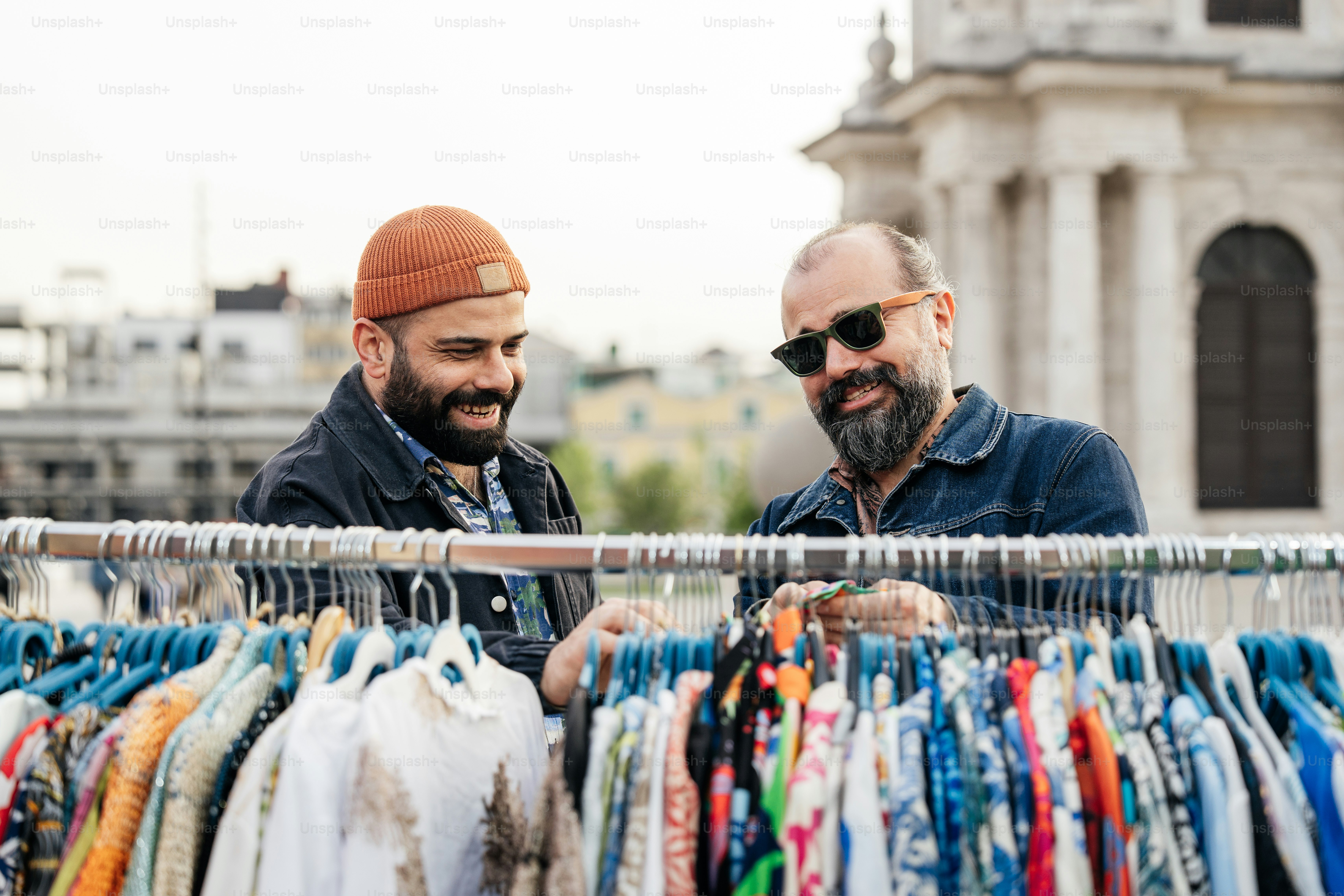 Two men are browsing through vintage clothing. photo – Family Image on ...