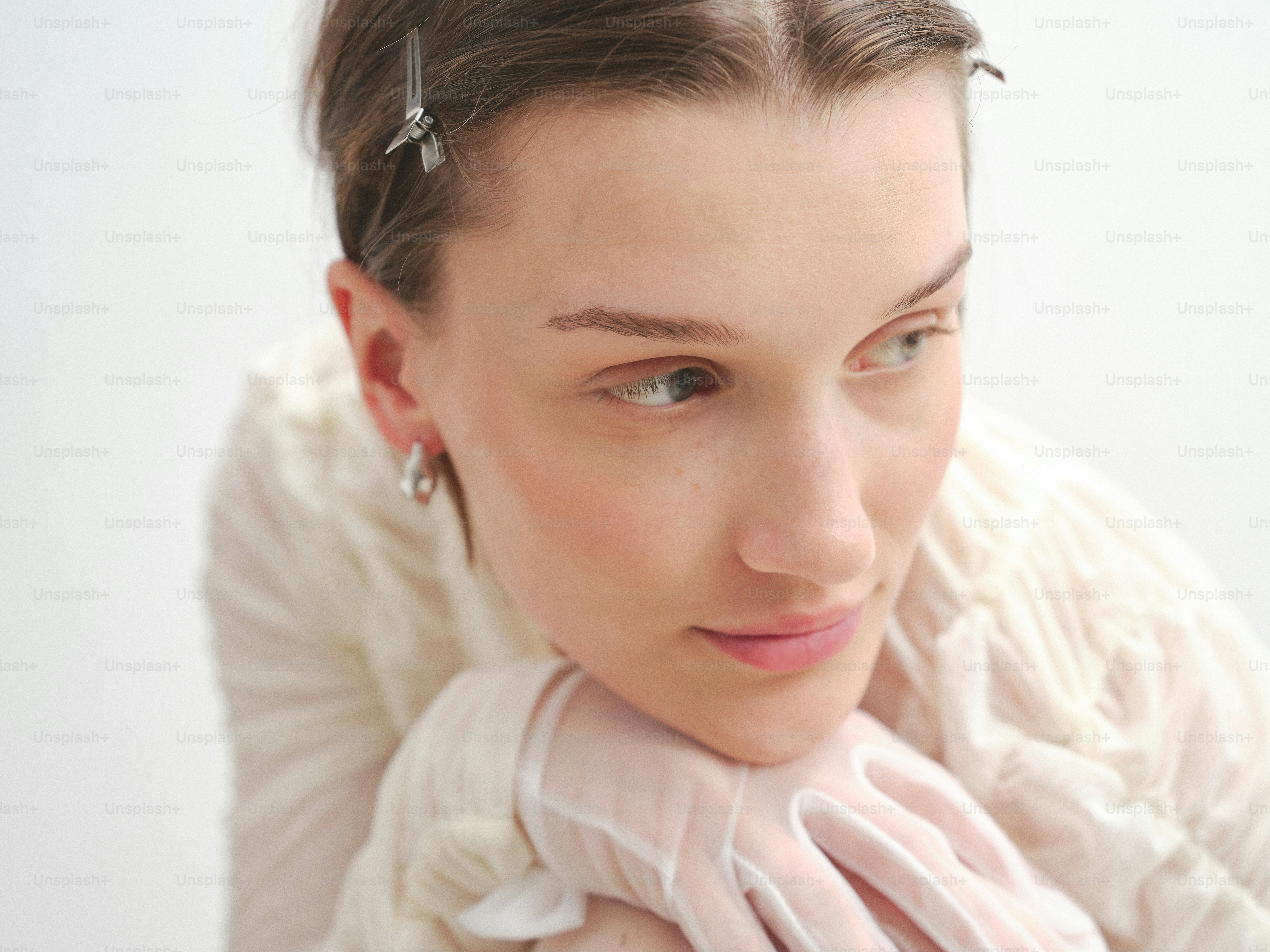 Young woman poses with gloved hands and a thoughtful expression. photo ...