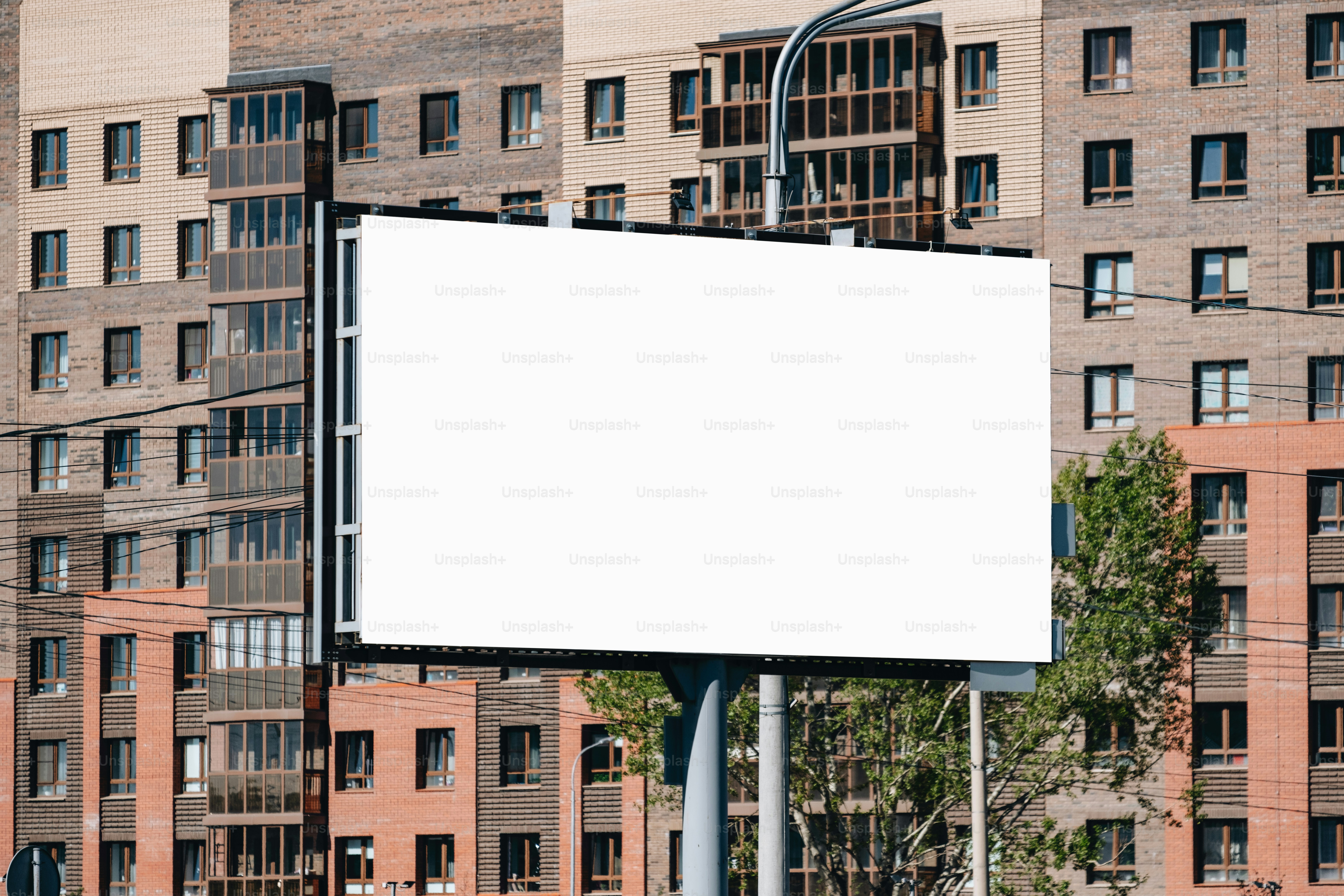 Blank billboard stands in front of an urban backdrop. photo – City ...
