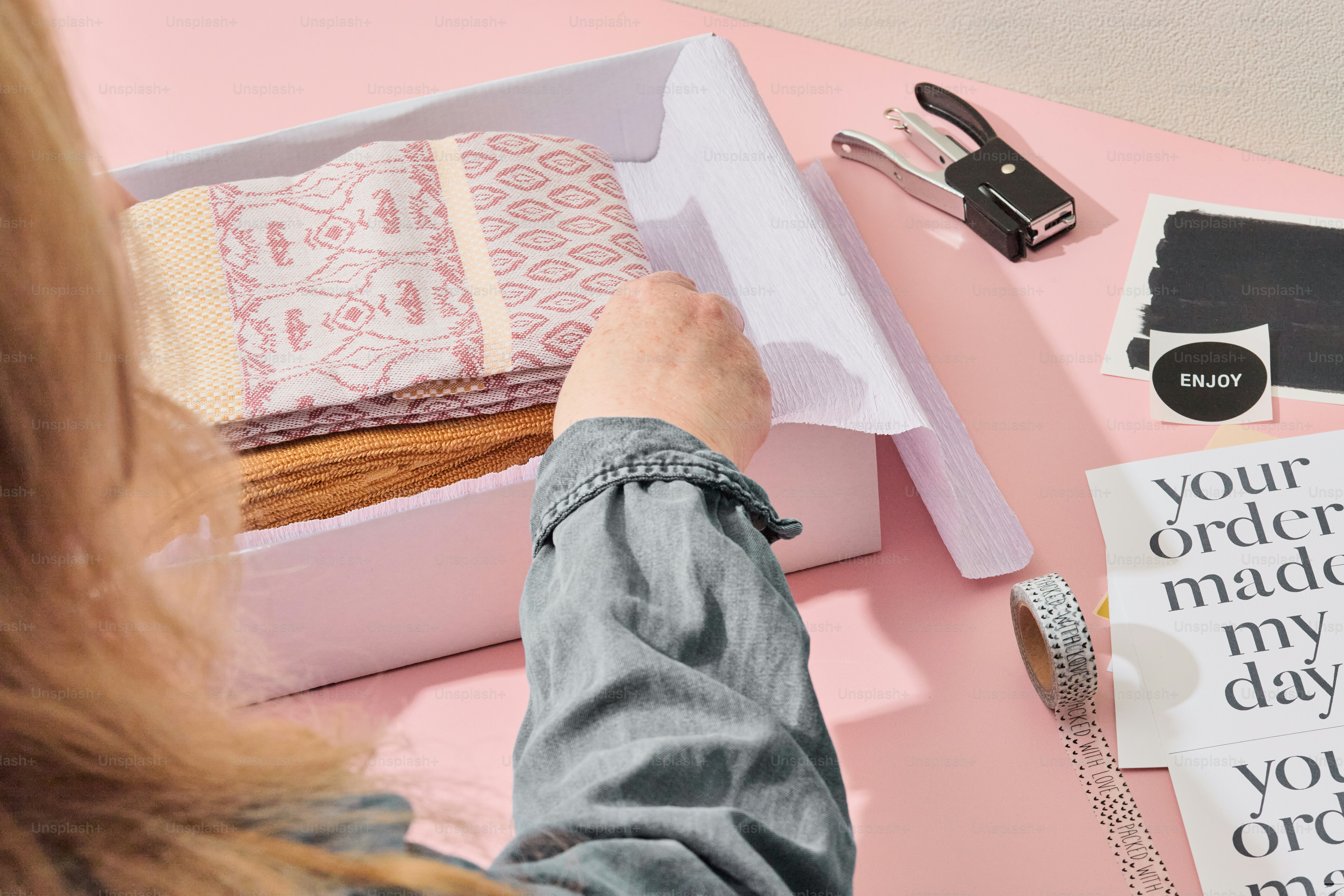 Someone packing an order inside a box. photo – Small business Image on ...