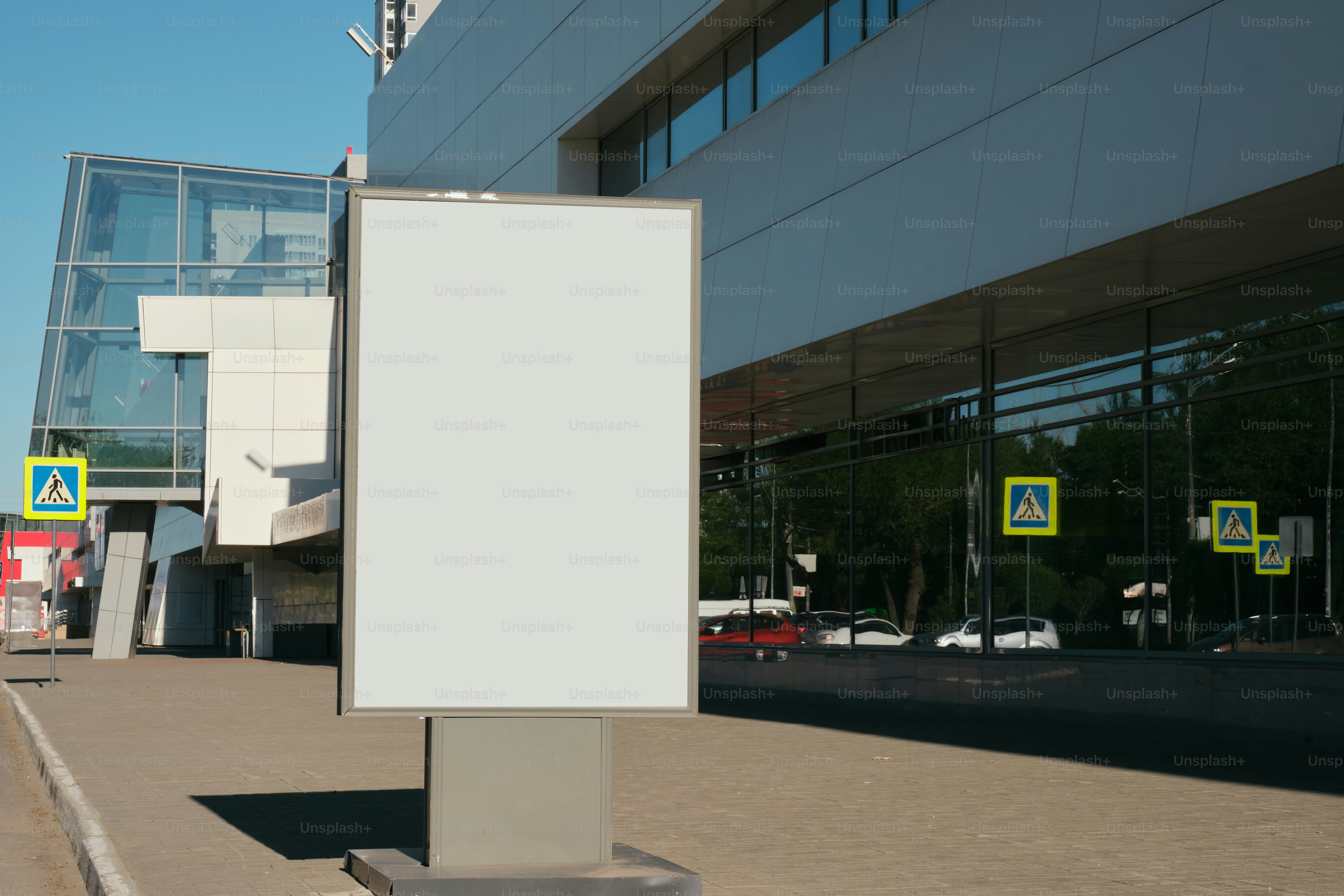 Blank billboard stands in front of a modern building. photo – City ...