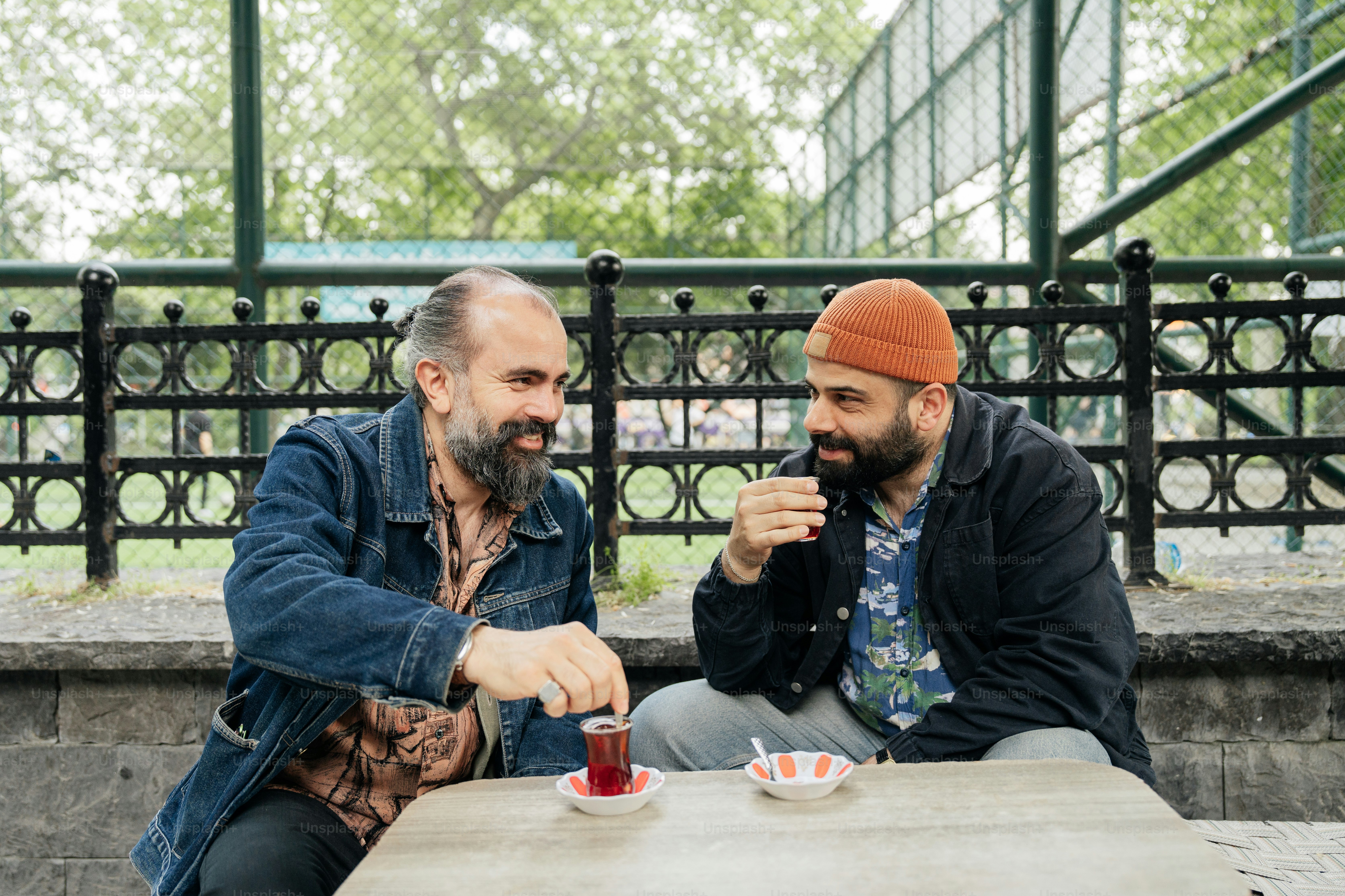 Two men enjoy tea together in a park. photo – Community Image on Unsplash
