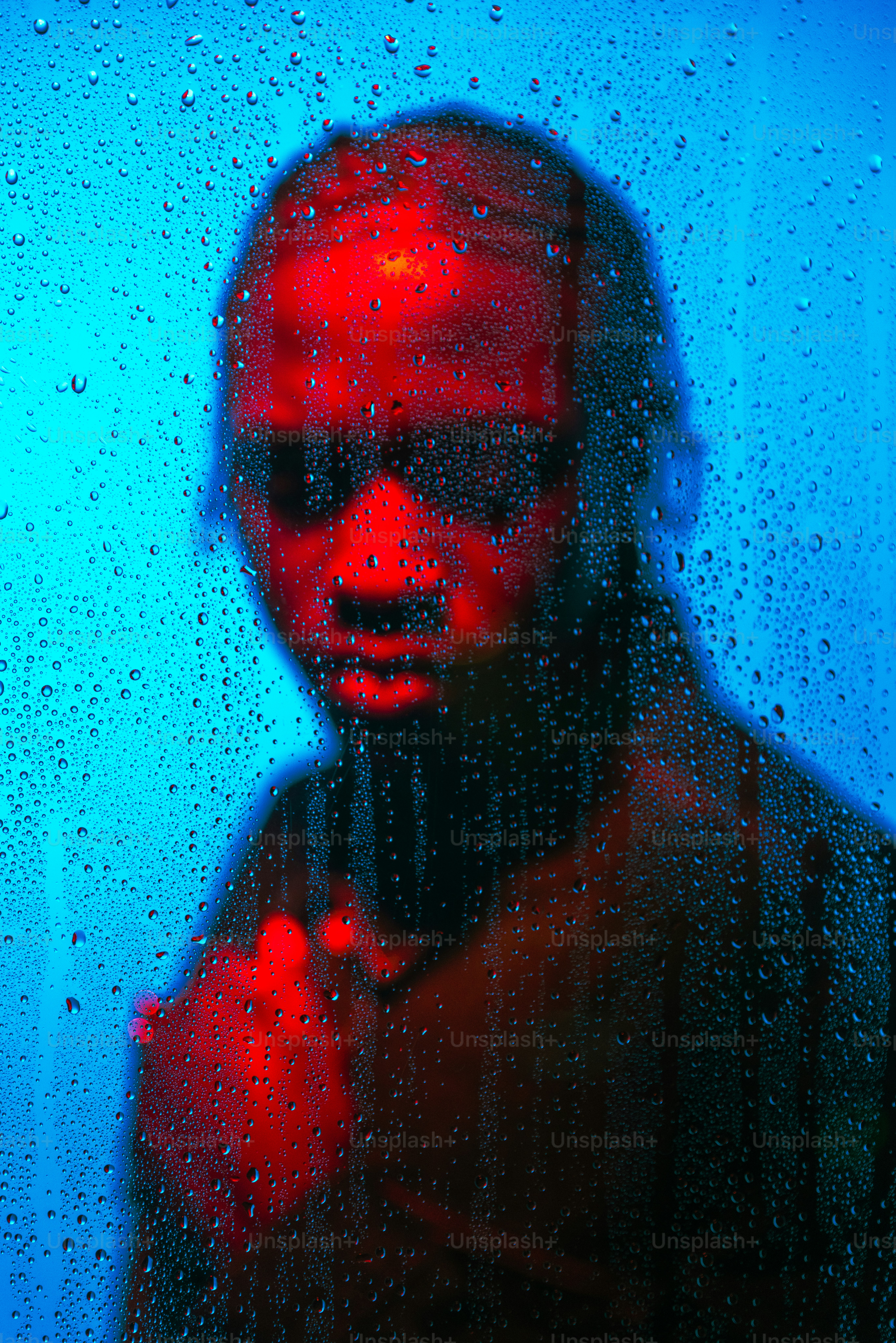 Green figure behind a textured glass pane. photo – Portrait Image on ...