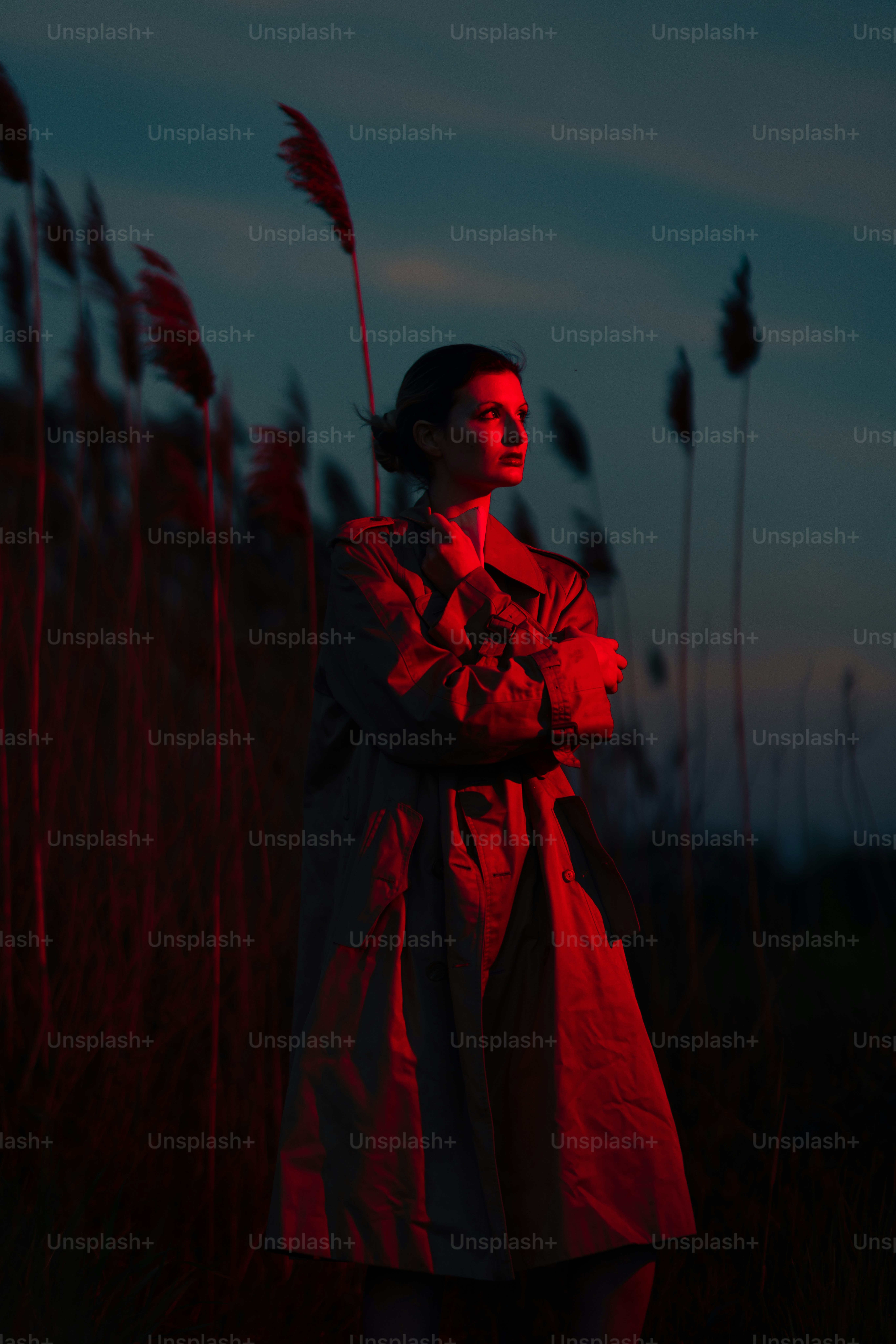 Woman poses in a studio lit by red light. photo – Portrait Image on ...