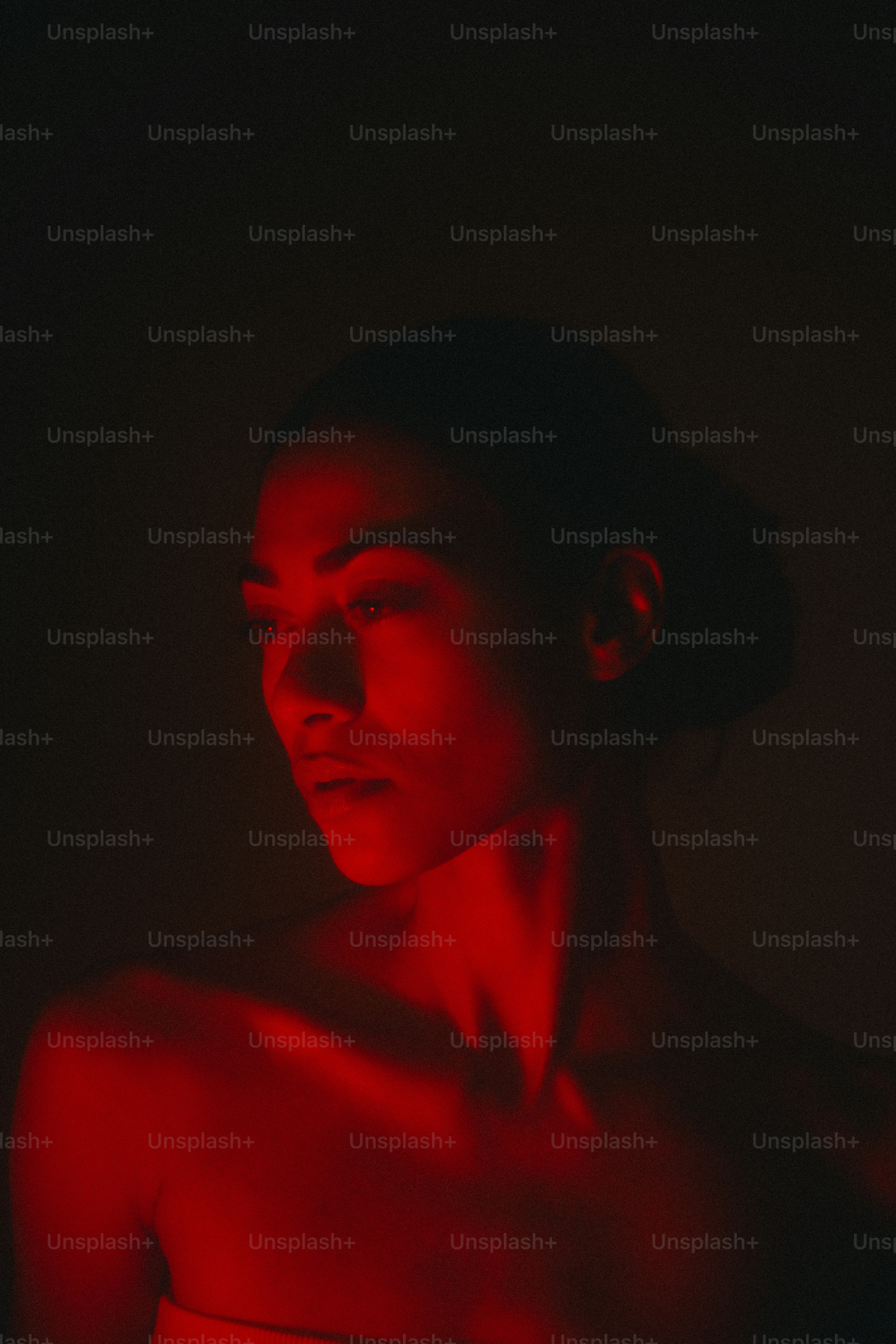 A woman's face is illuminated by red light. photo – Portrait Image on ...