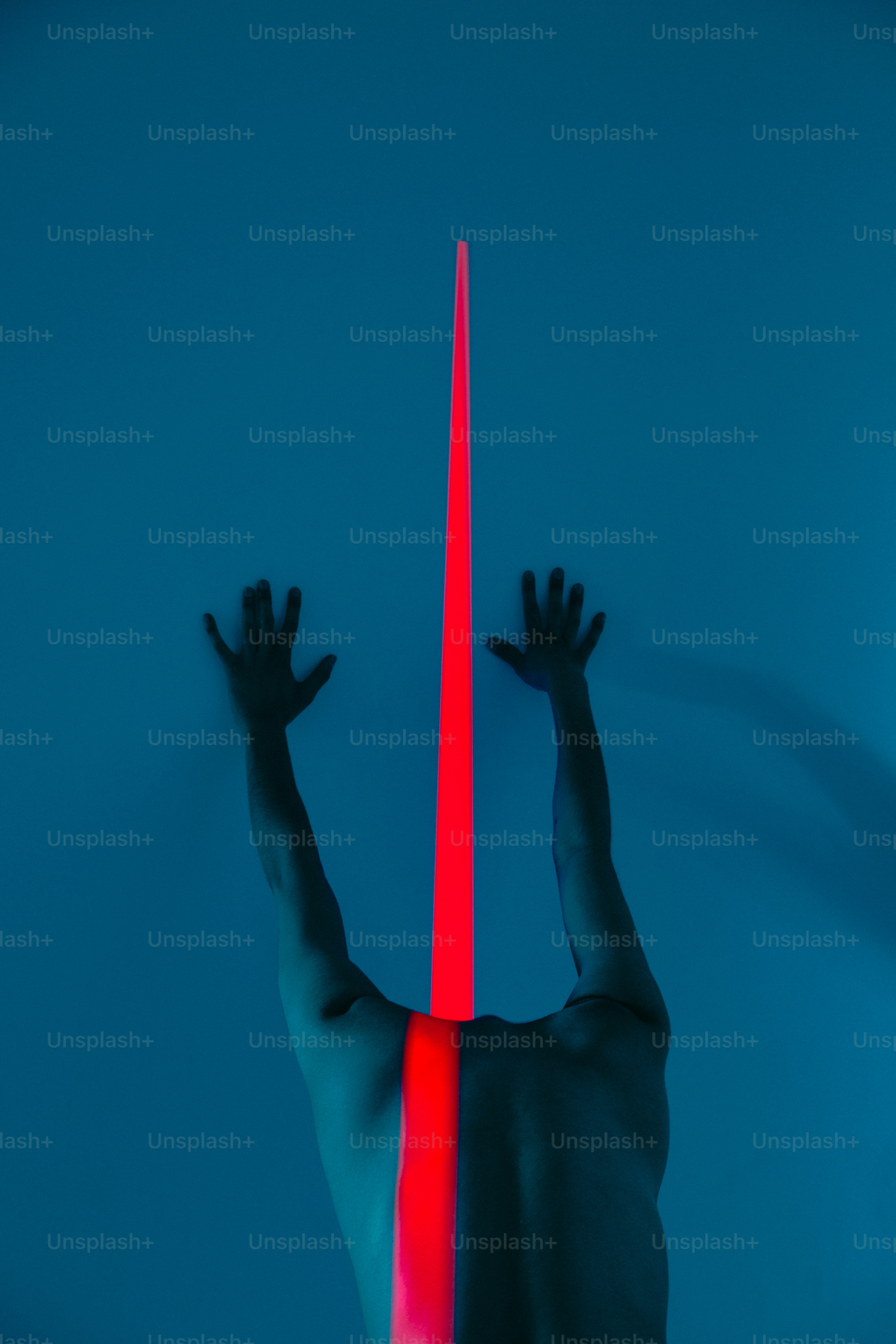 A person's body with a bright red beam. photo – Portrait Image on Unsplash